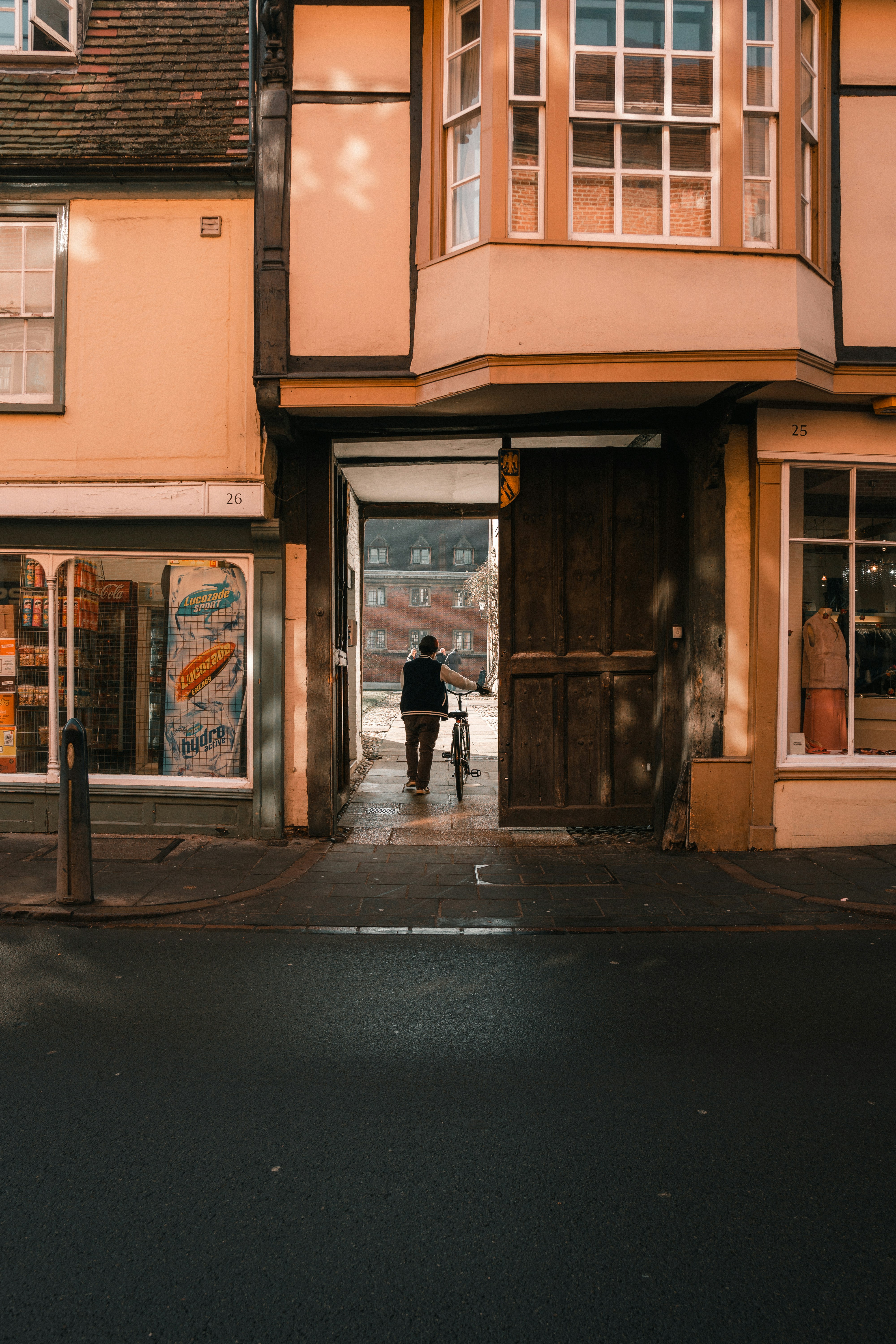 A person walking out of a doorway into a building photo – Free ...