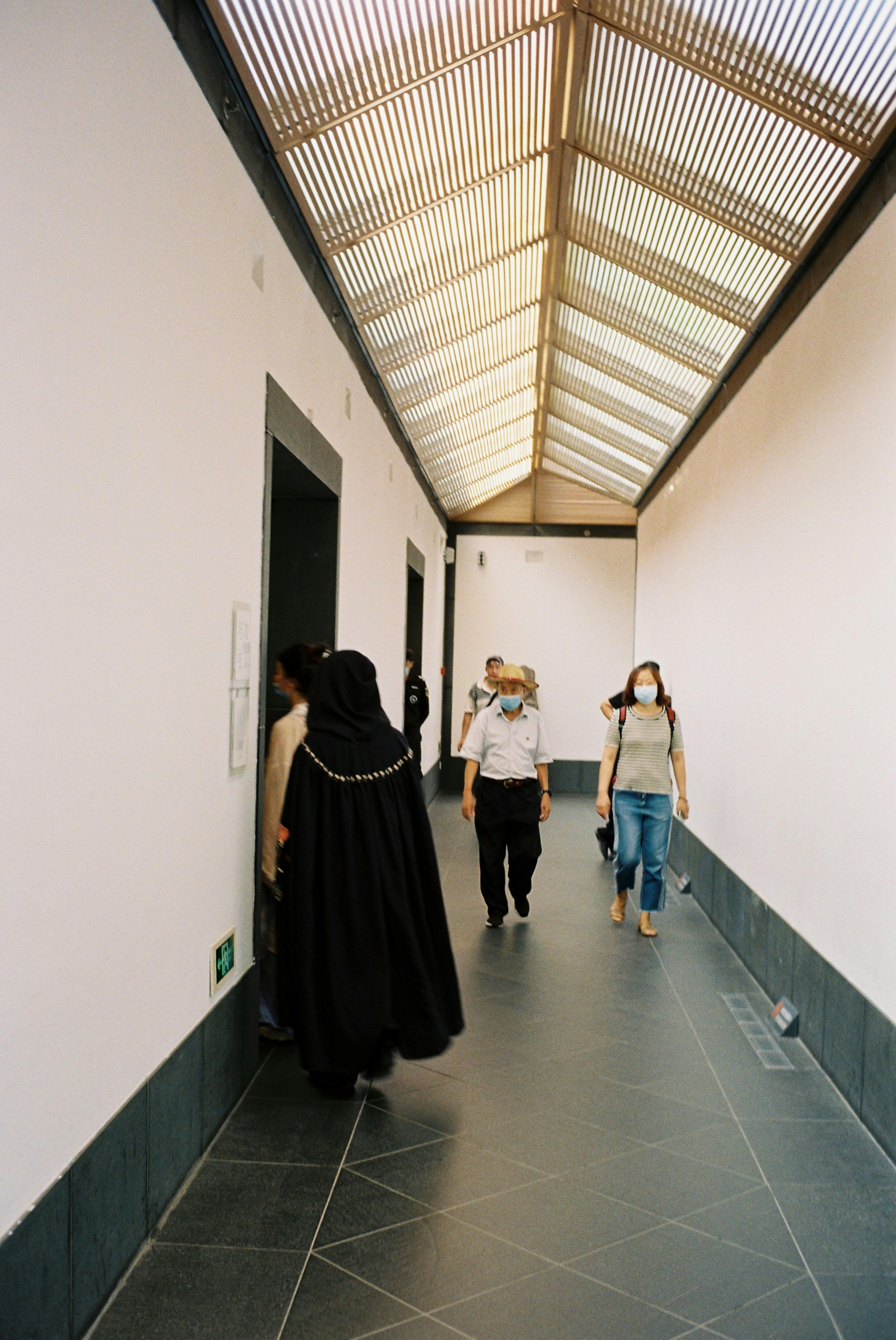A group of people walking down a hallway photo – Free 看不透的城市 Image on ...