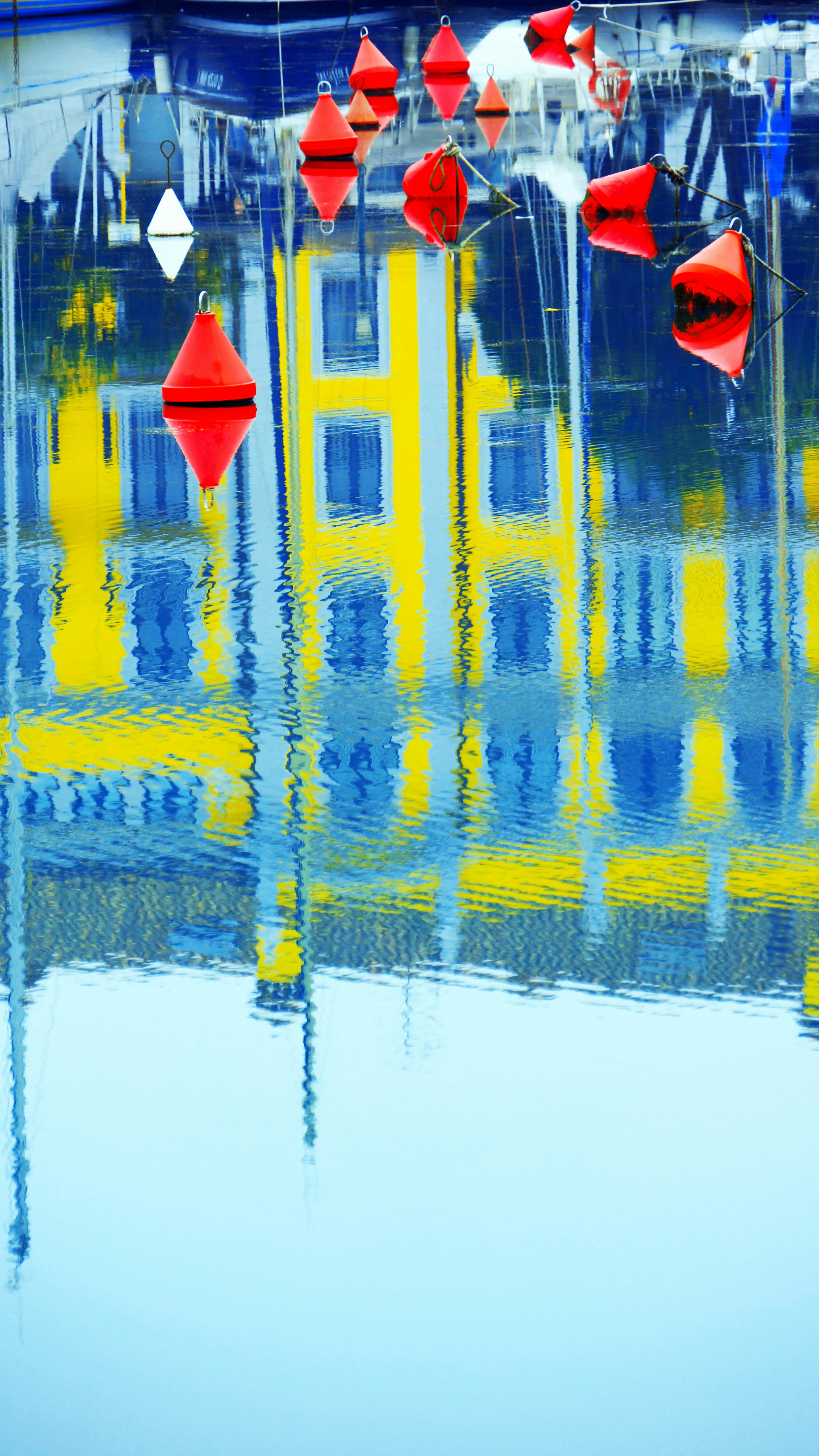 Crimson Buoys Amid Neon Harbor Reflections