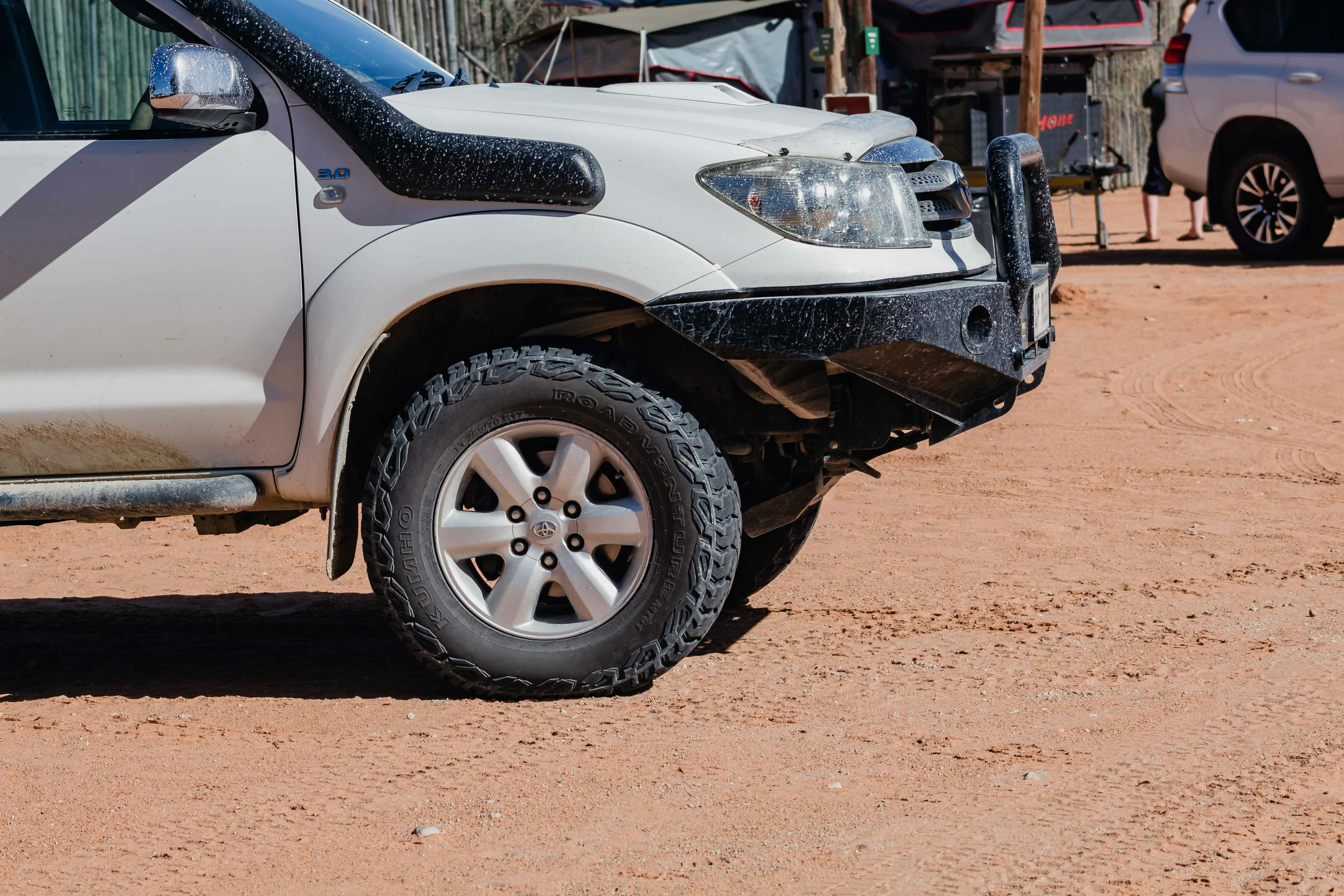 Front-Quarter View of a Rugged Pickup in a Desert Compound
