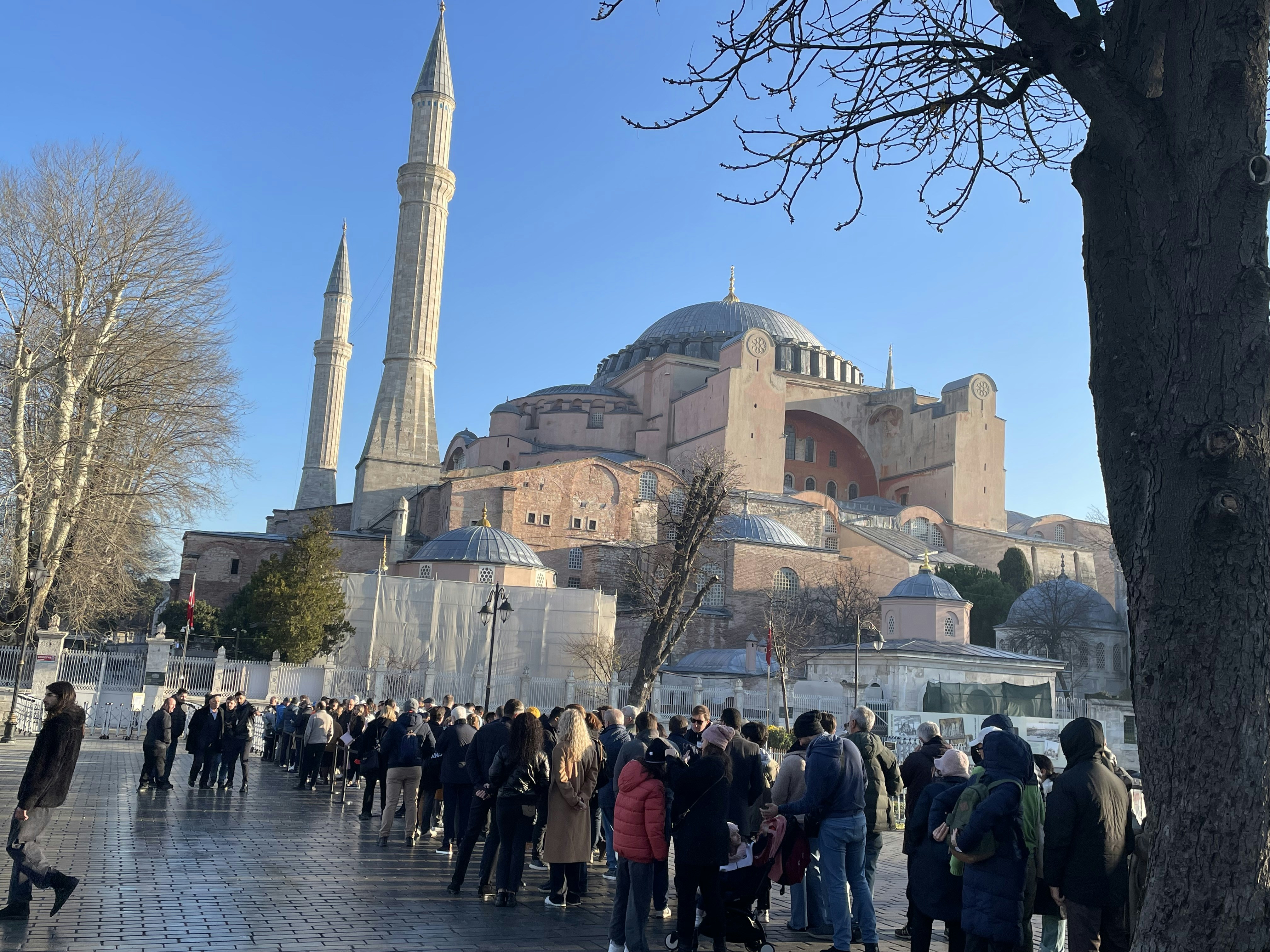 A crowd of people standing in front of a building photo – Free Building ...