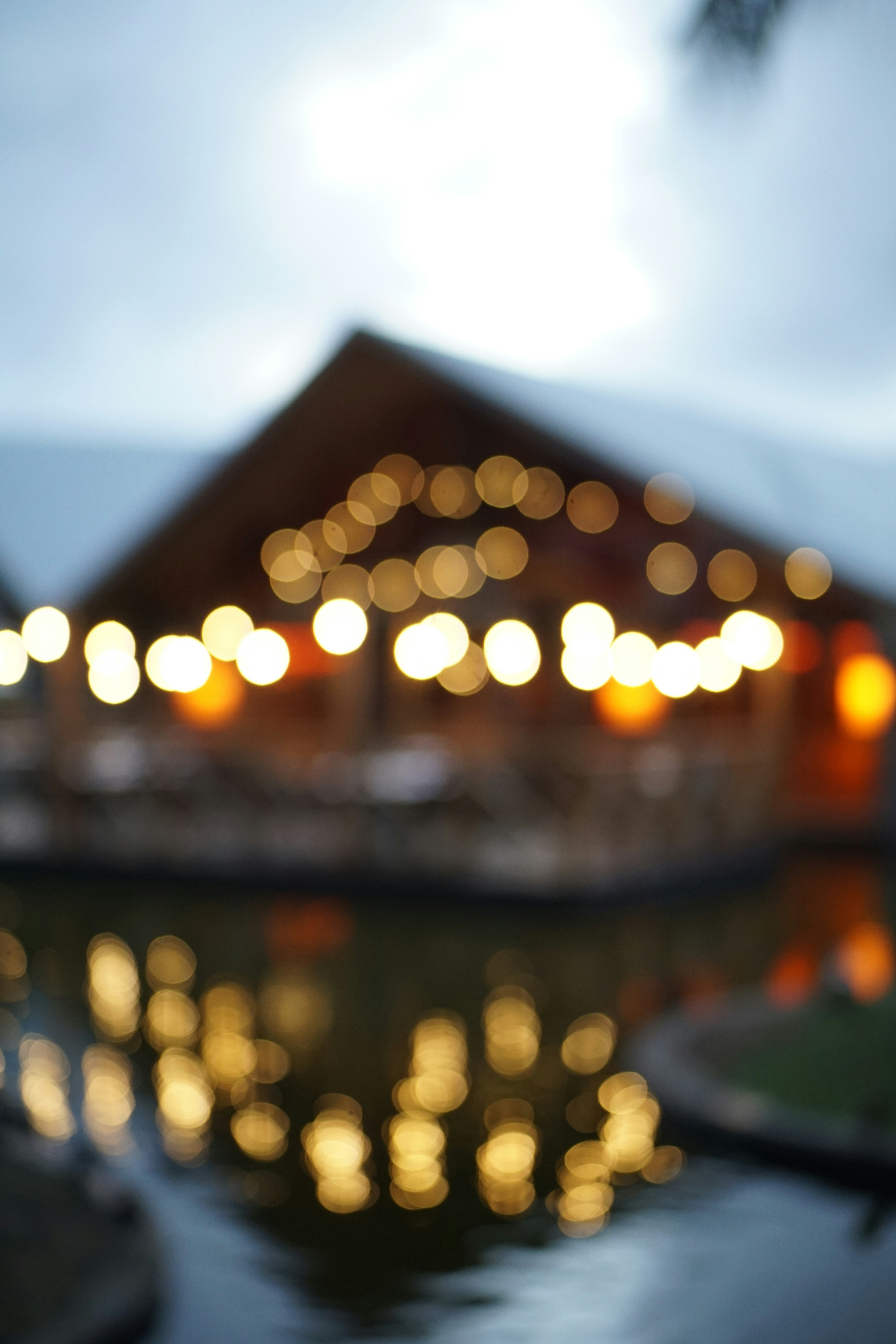 Warm Lanterns Over a Blurred Waterfront Pavilion