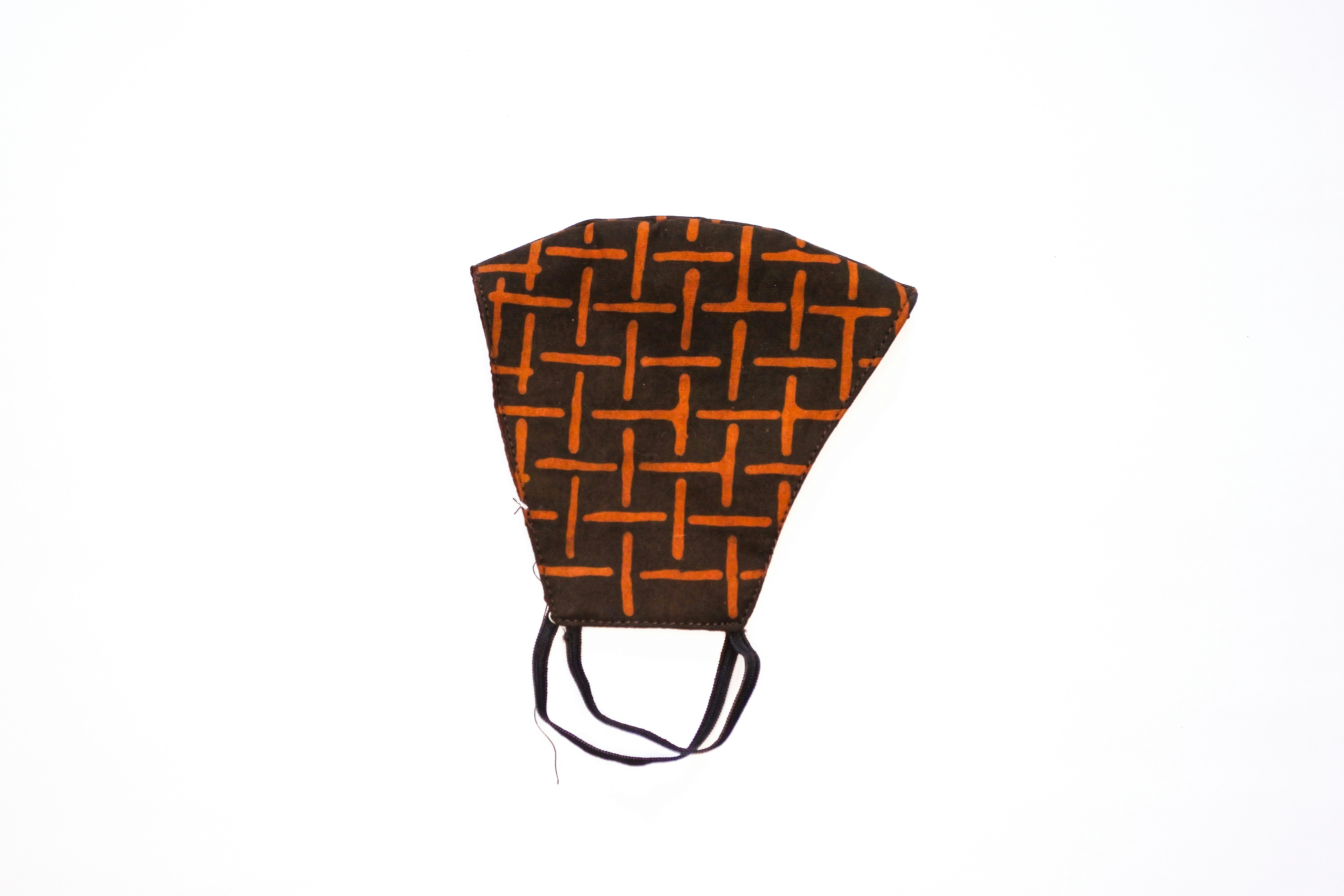 Masked Pattern: A woven face shield perched on white emptiness