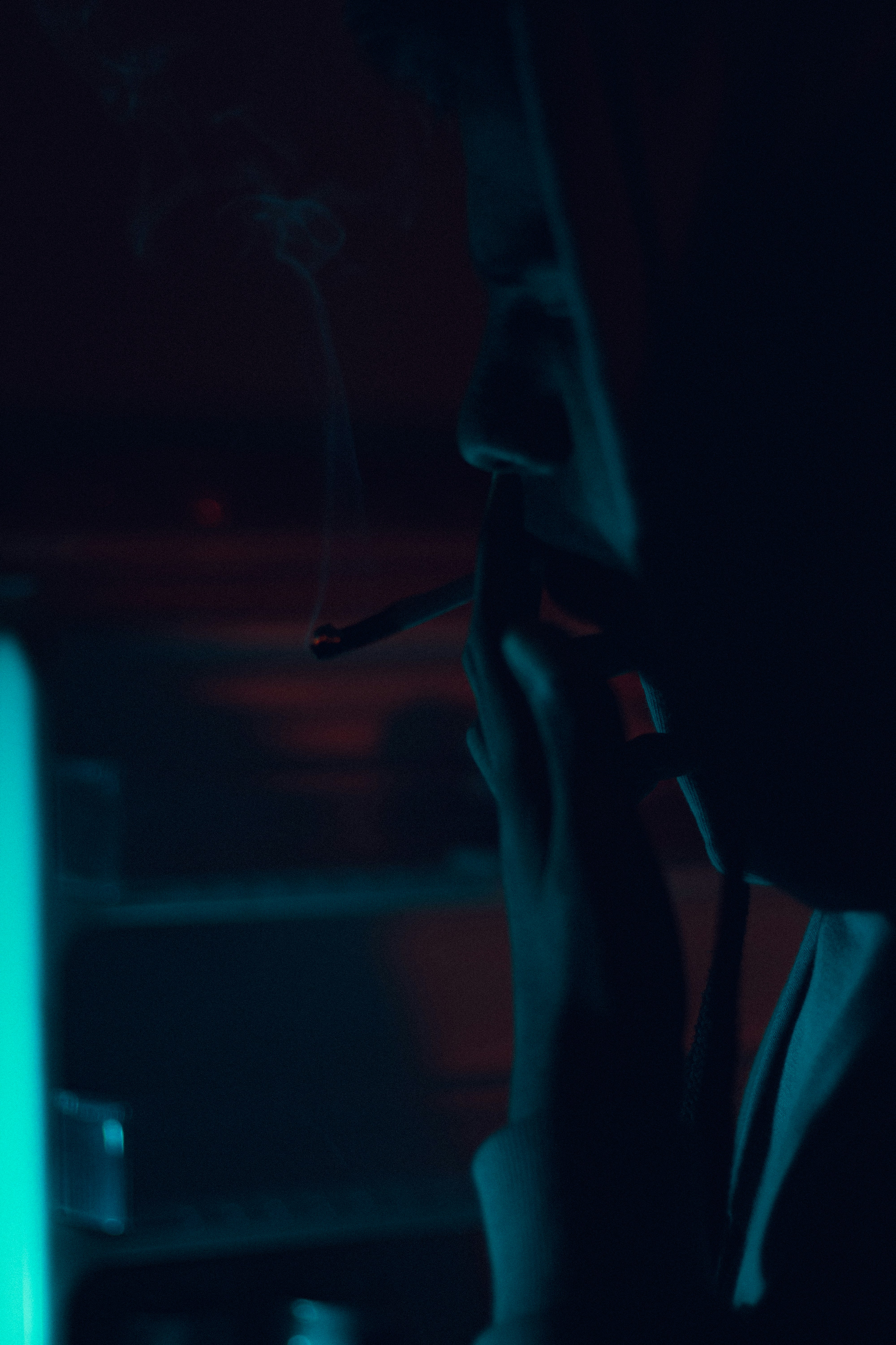 A man smoking a cigarette in a dark room photo – Free Smoking Image on ...