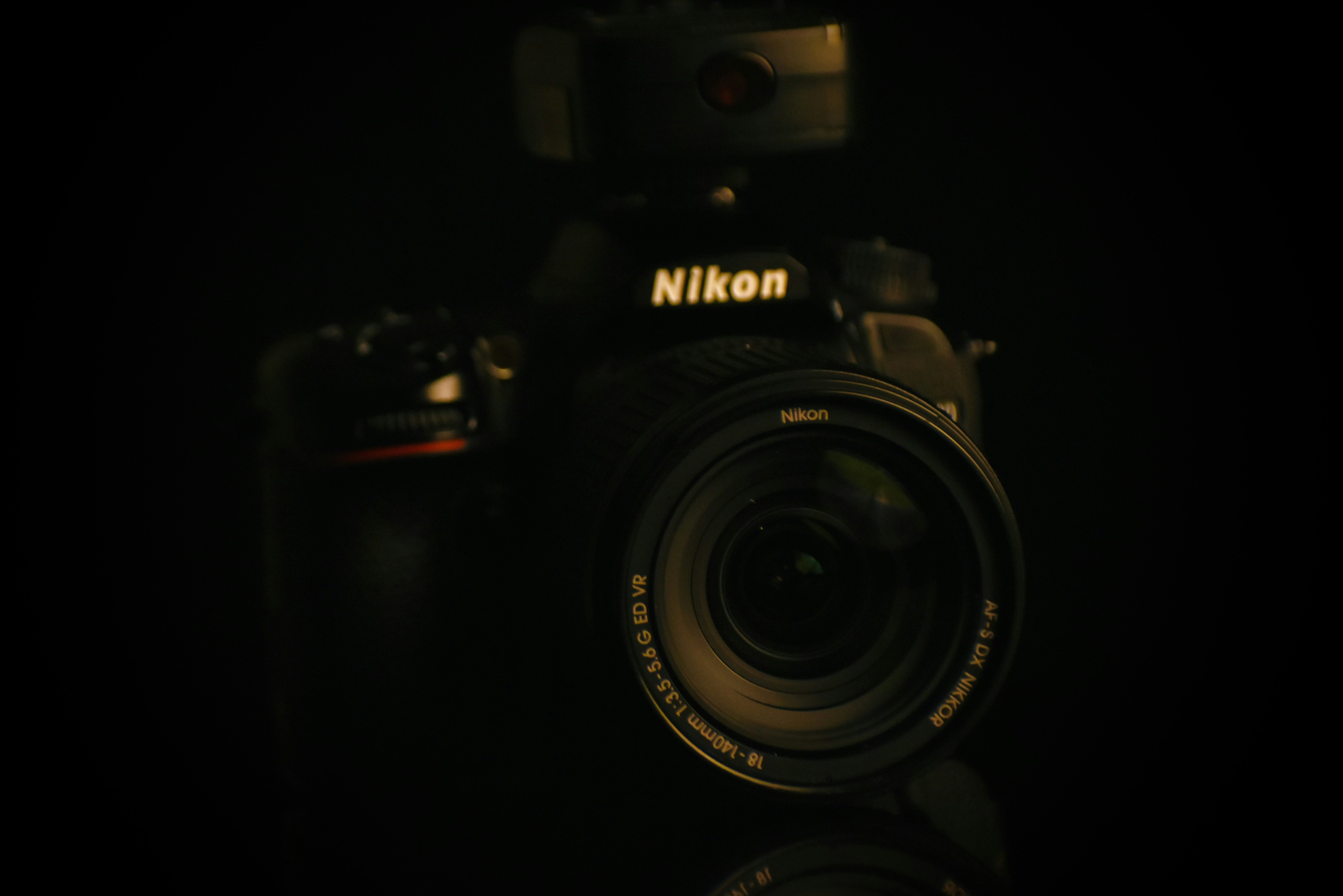 A black camera with a nikon lens in the dark photo – Free Photography ...