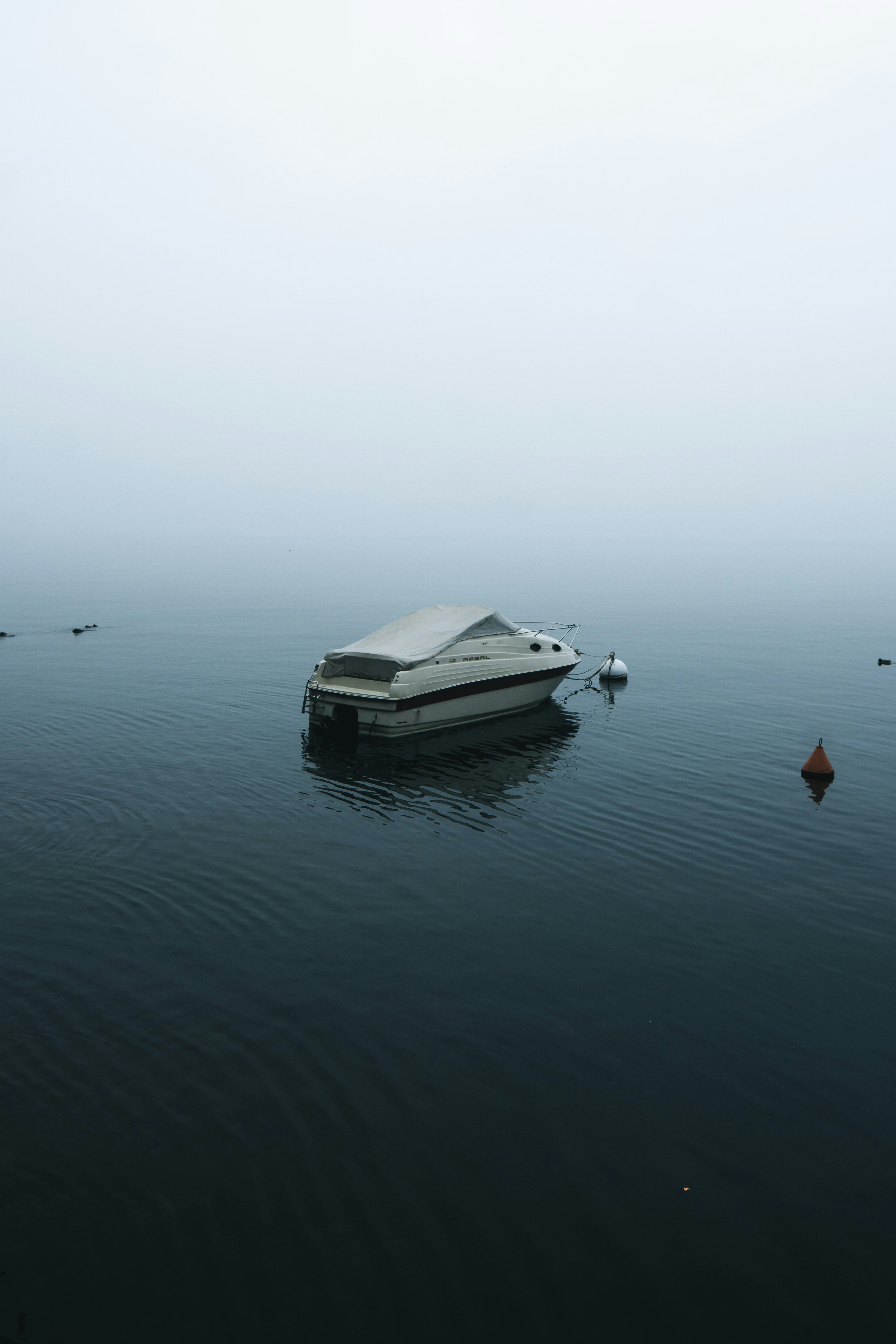 A boat floating on top of a body of water photo – Free Boat Image on ...