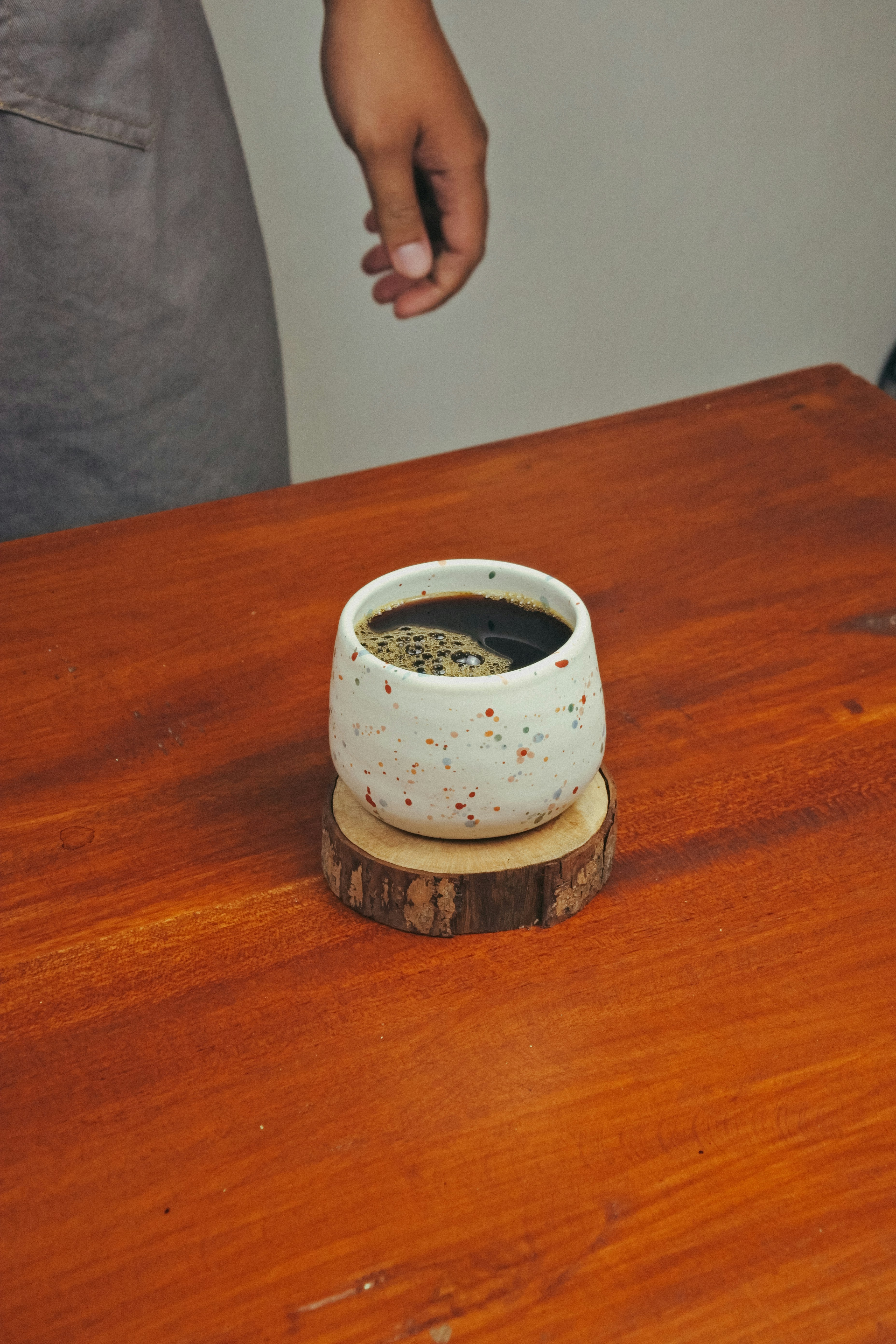 a cup of coffee sitting on top of a wooden table