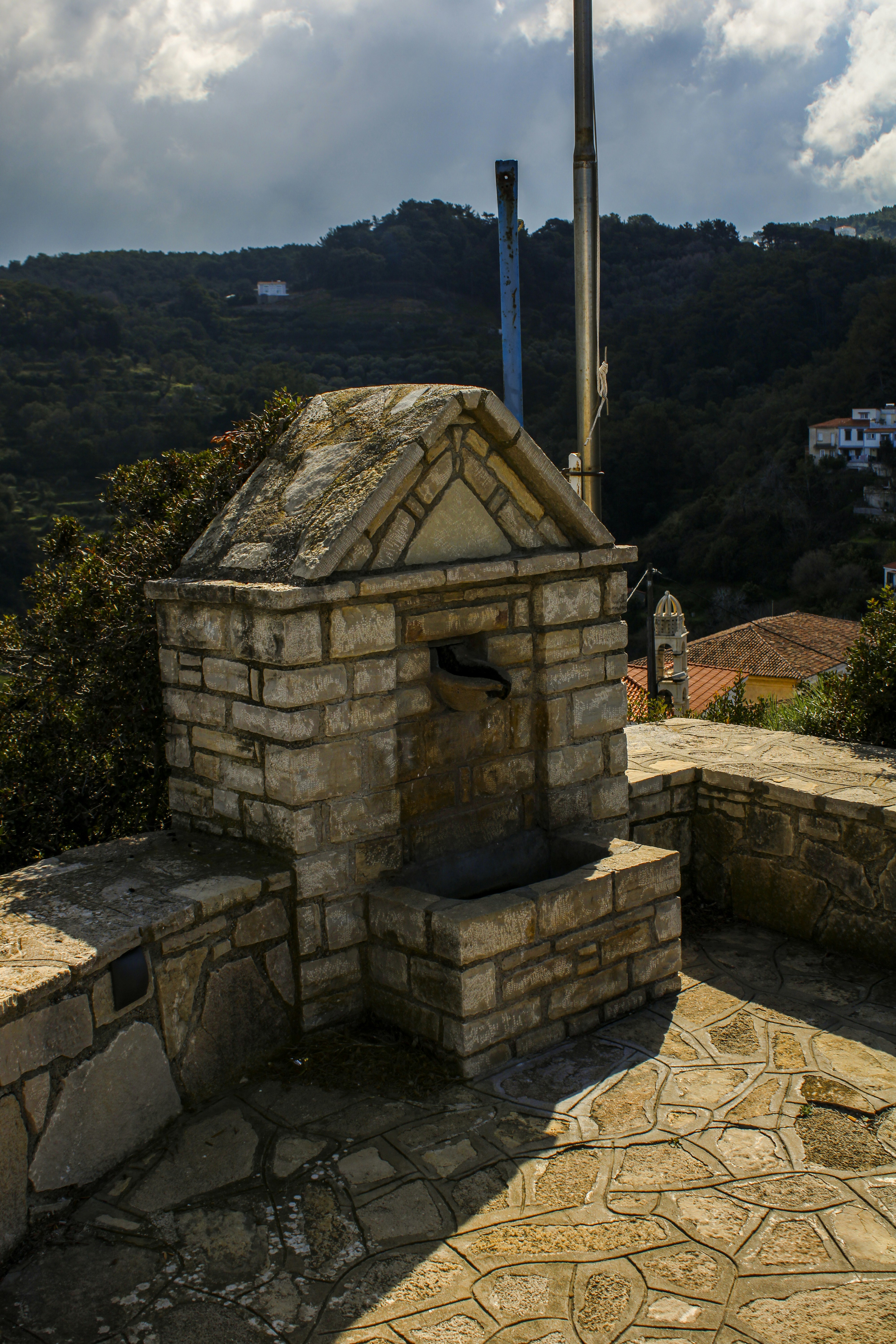 Terrace Stone Fountain Framing a Hilltown Panorama