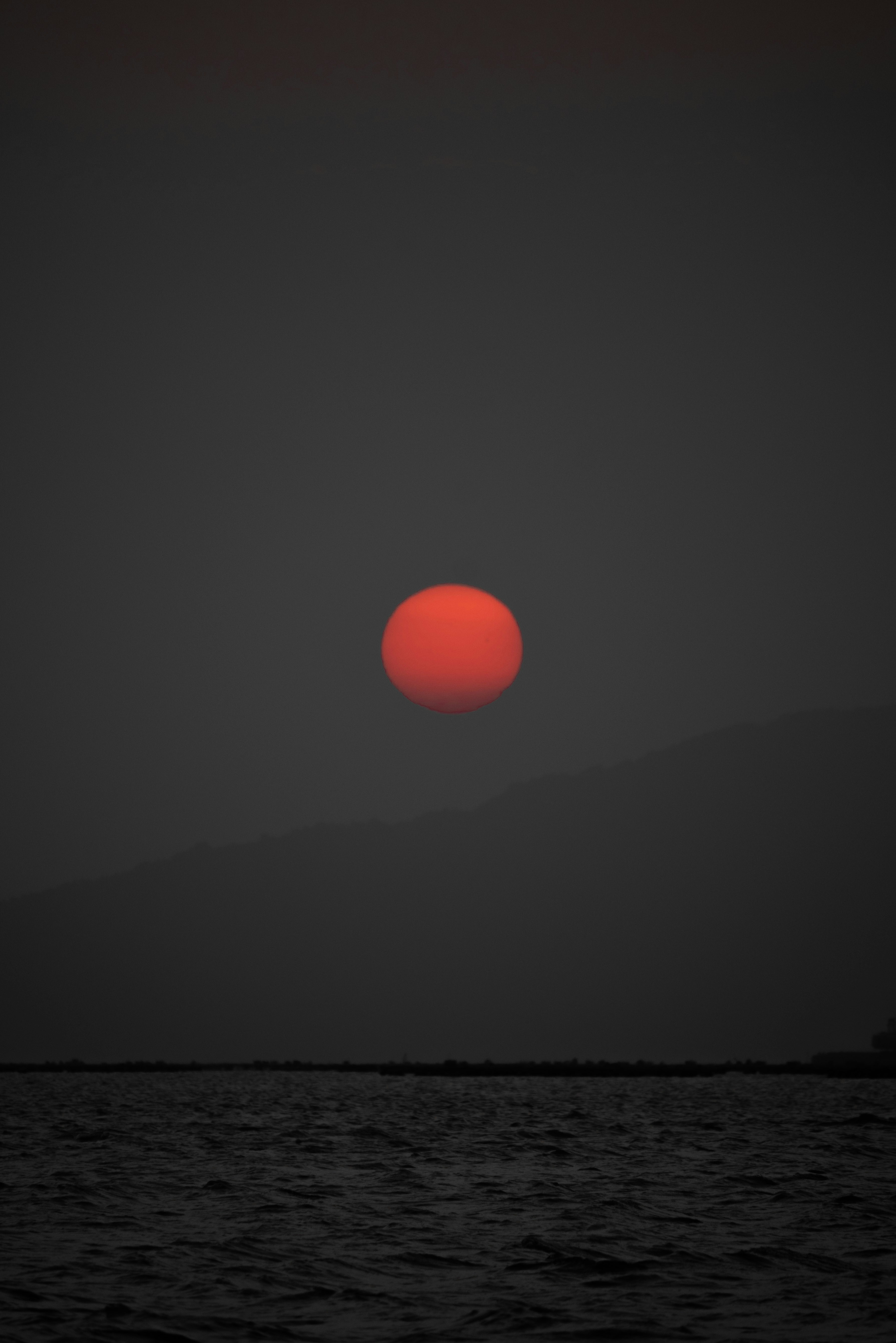 the sun is setting over a body of water