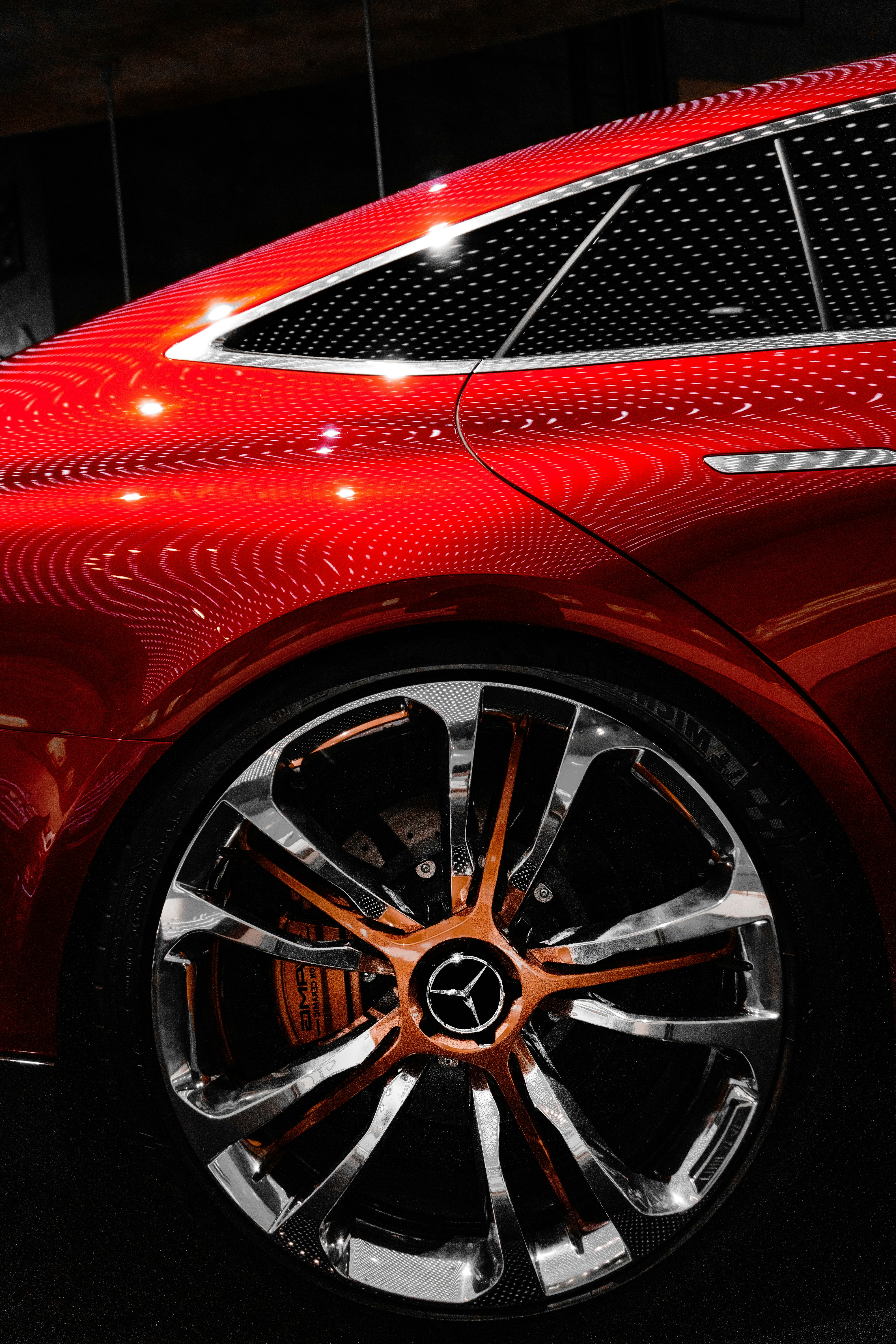 Crimson Curves and Alloy Spokes: Studio Close-Up of a Red Car Wheel