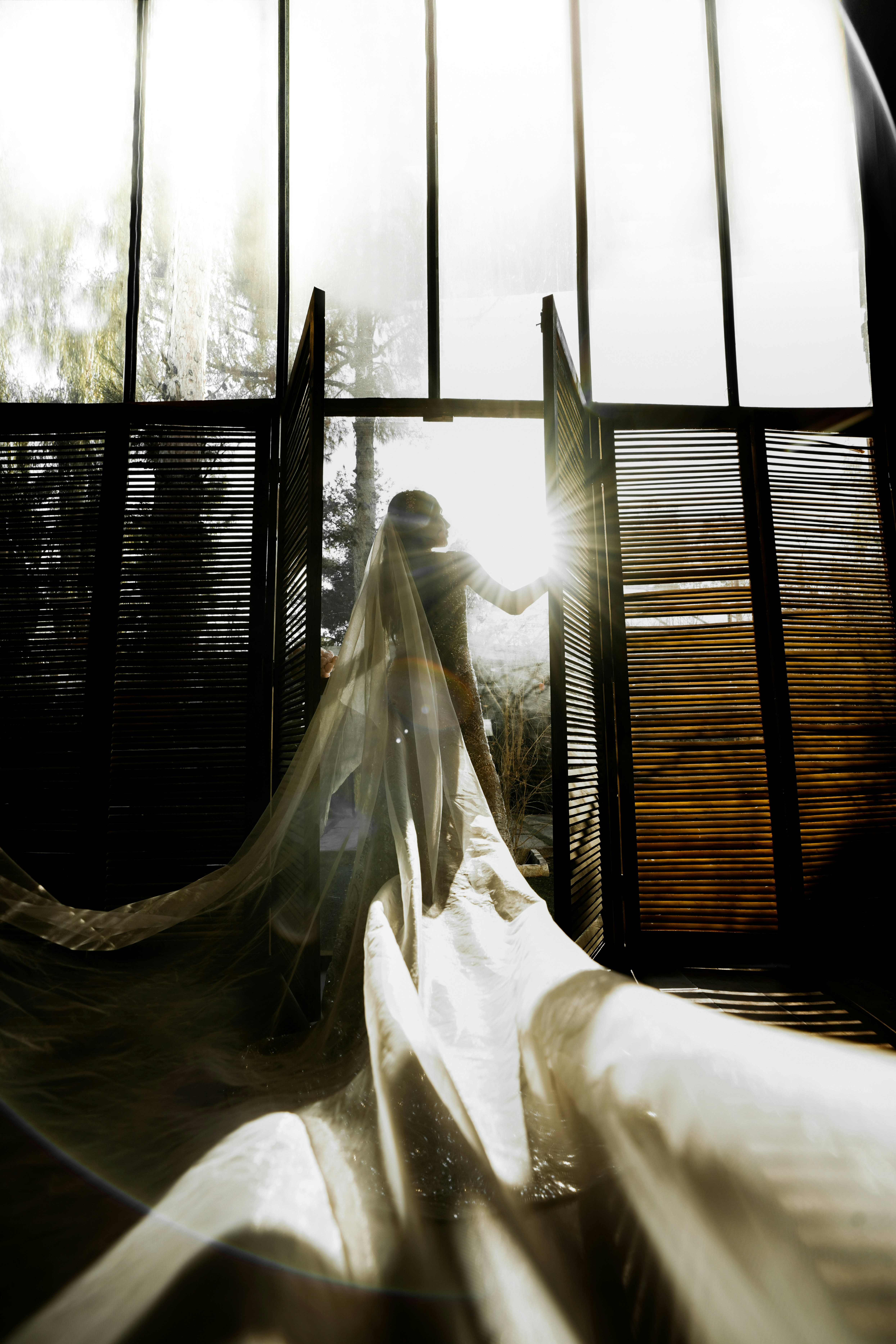 a woman standing in front of a large window