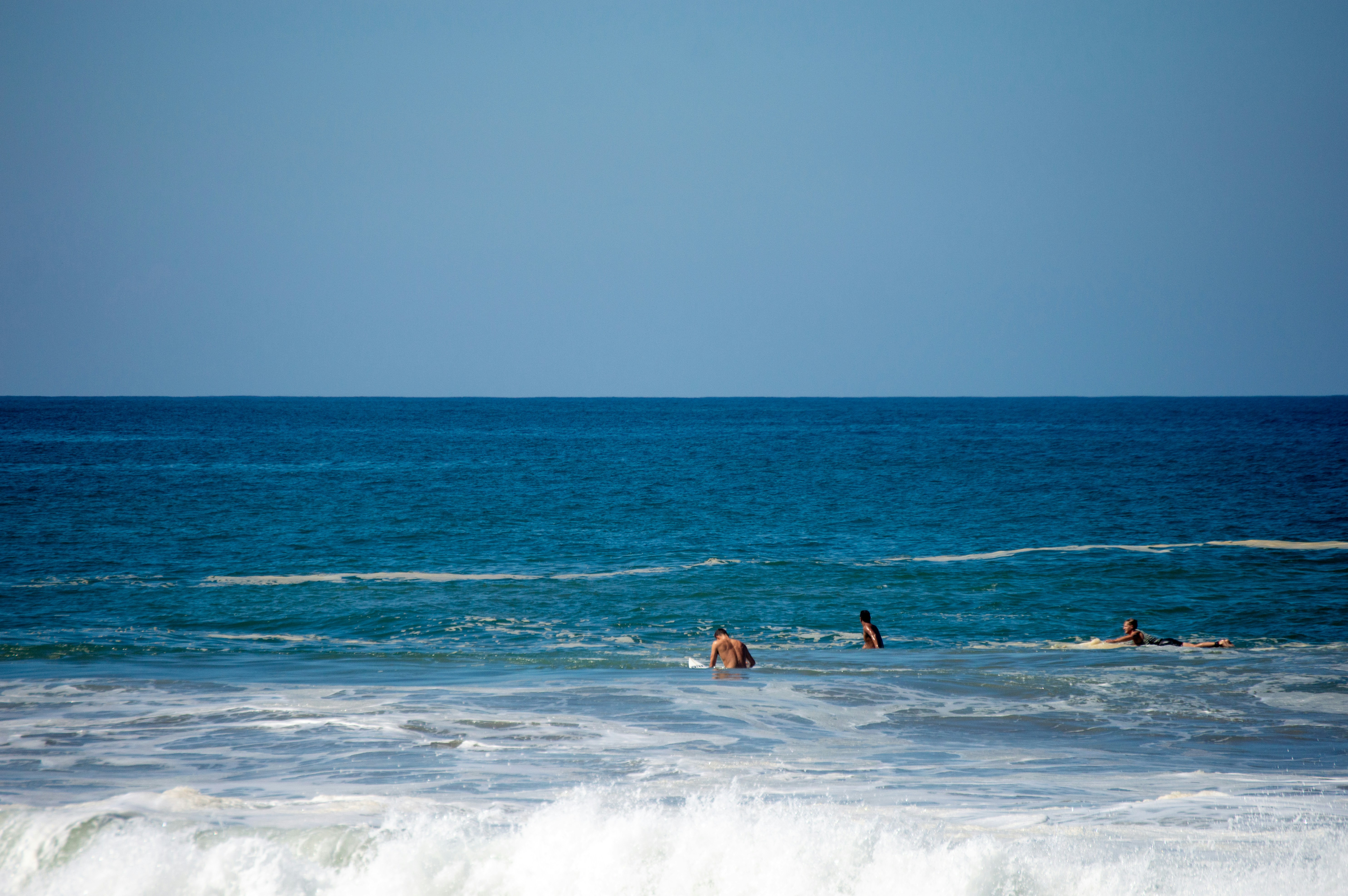 A group of people swimming in the ocean photo – Free Beach Image on ...
