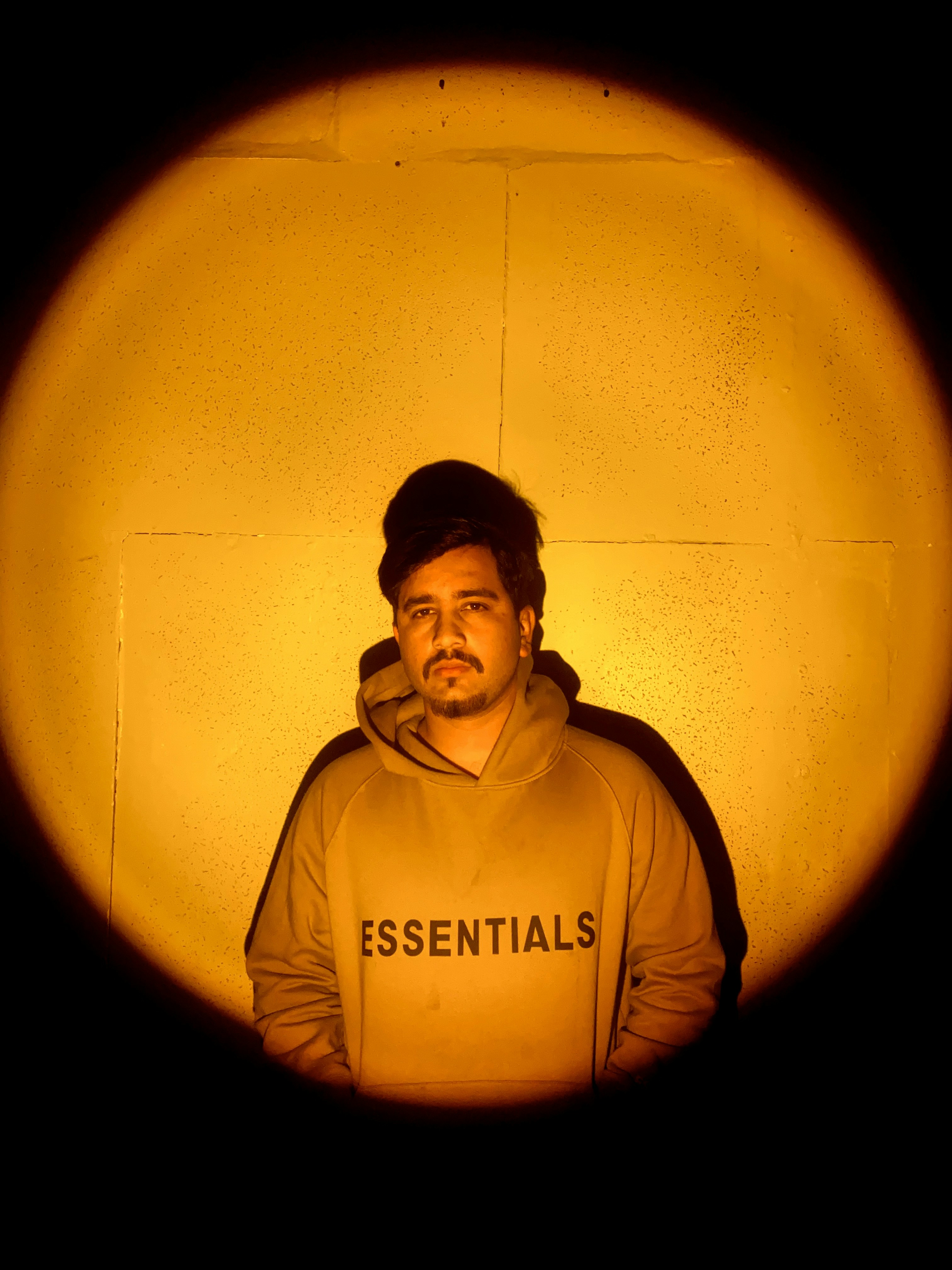 A man standing in front of a yellow light photo – Free Fashion Image on ...