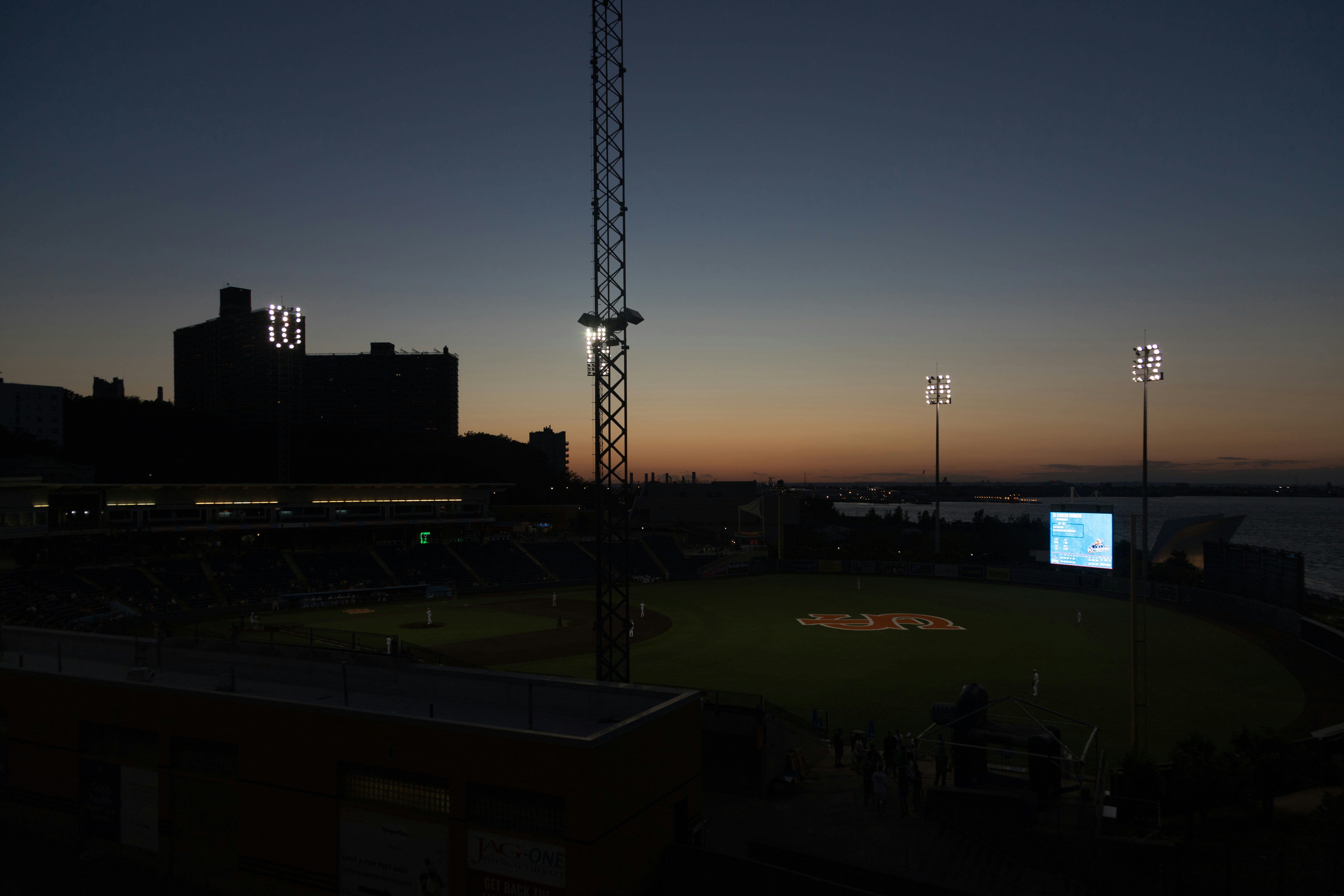 A baseball field at night with the sun setting photo – Free Stadium ...