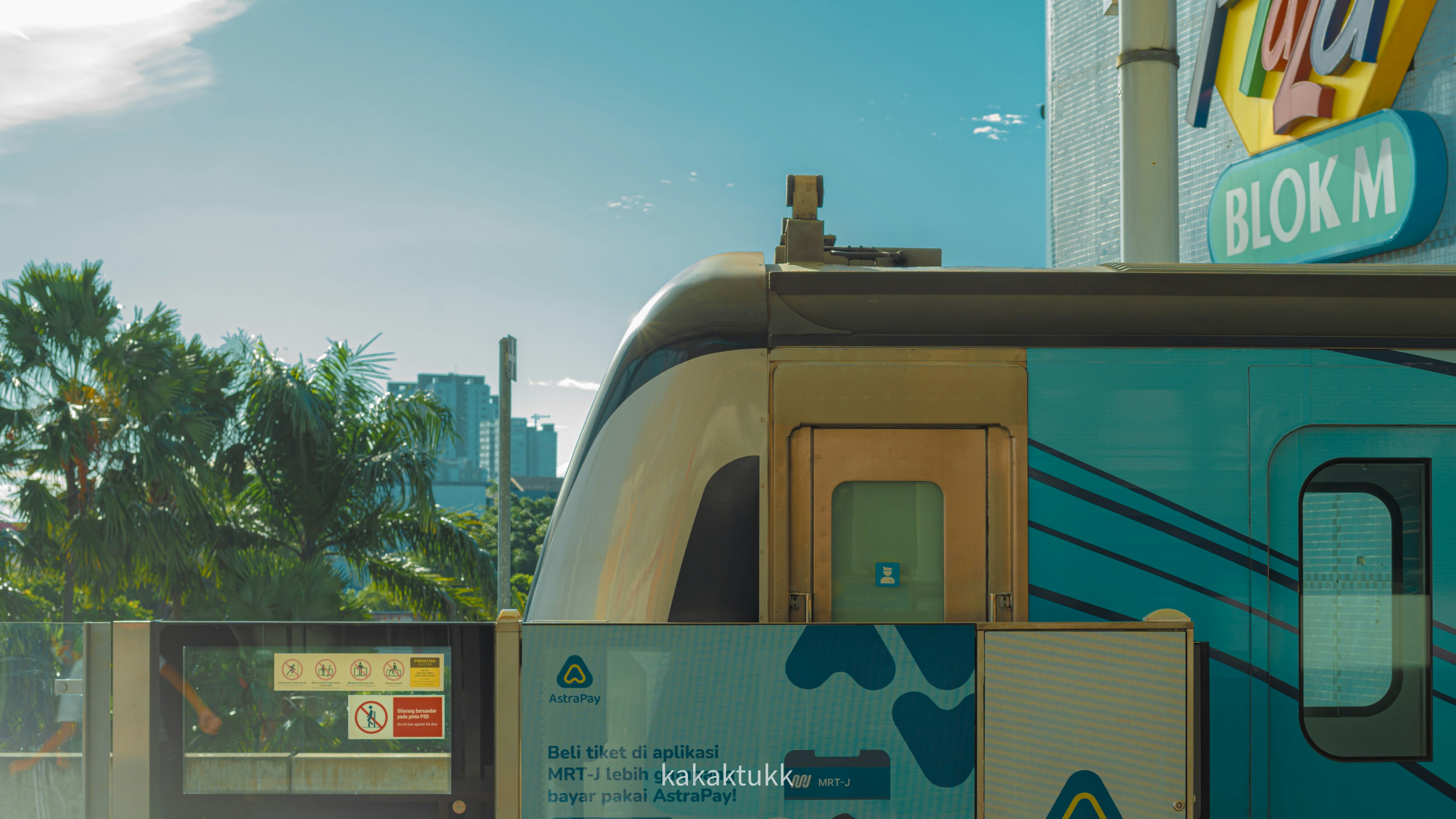 This photo showcases modern design of Jakarta's MRT train system. The train is captured in front of the iconic Blok M Plaza, adding a touch of local flavor to the urban scene. The photo highlights the efficient and convenient public transportation options available in the city, making it an ideal choice for travelers and locals alike.
