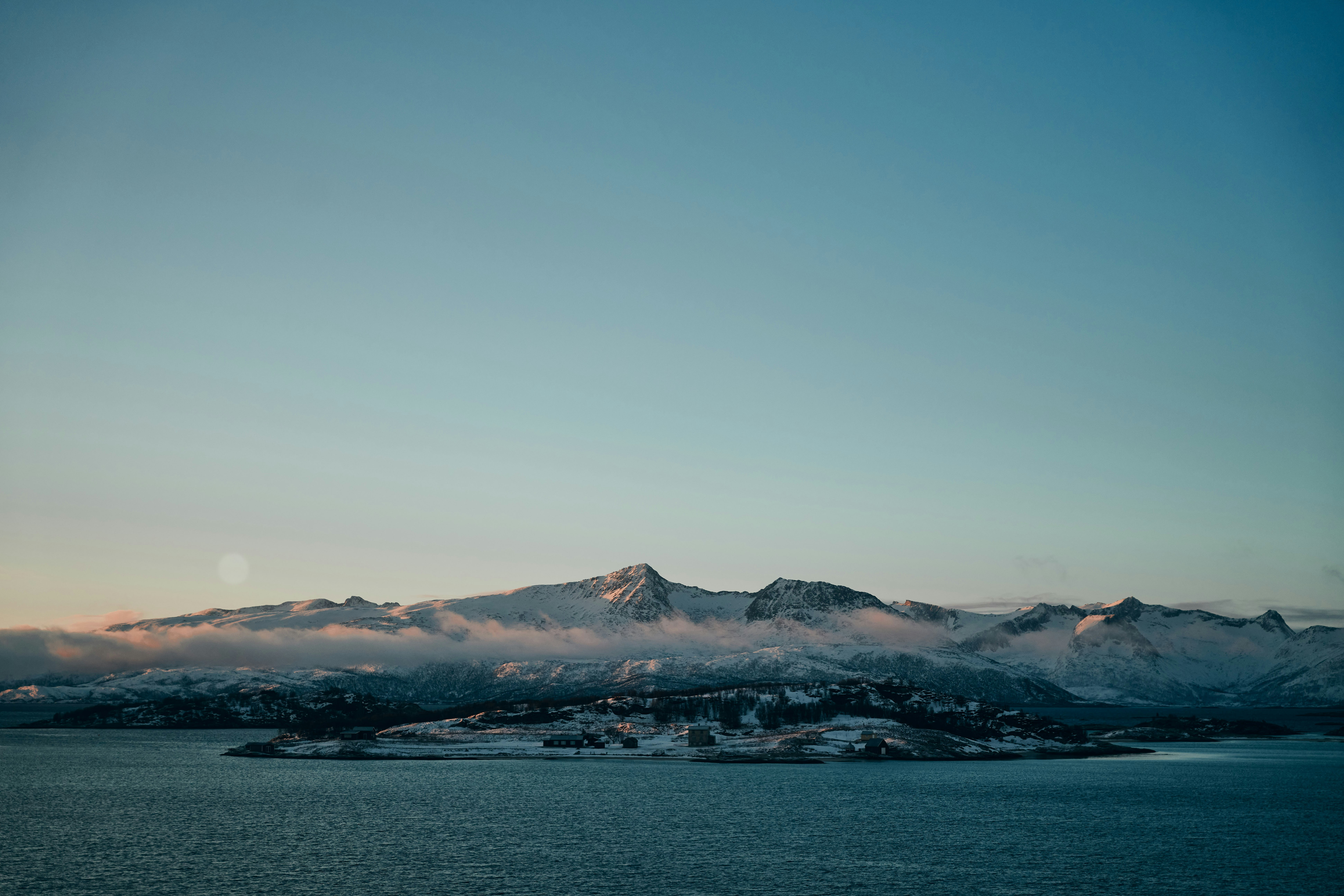a large body of water with a mountain in the background