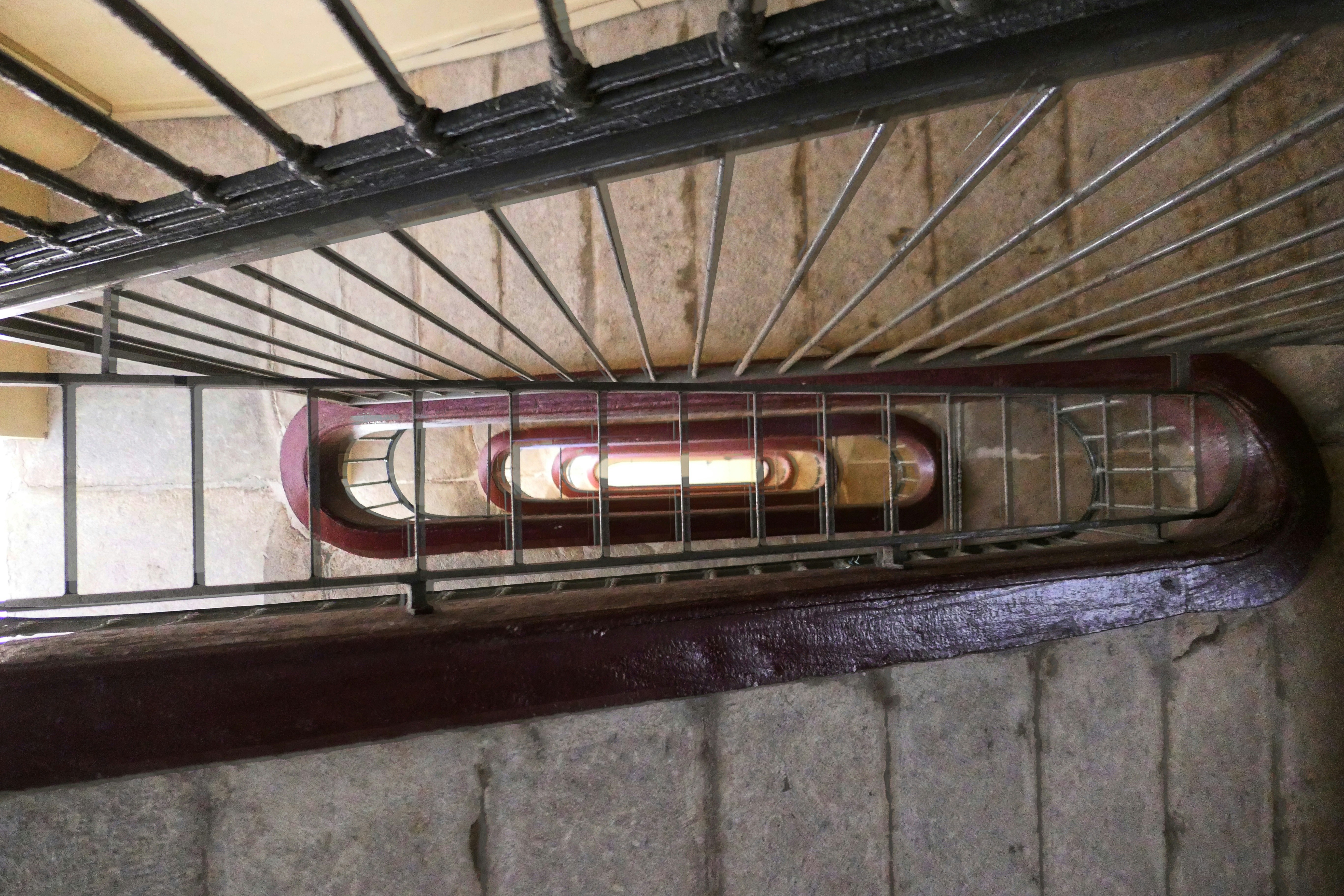 Overhead Descent: A Stairwell's Red Path through Steel and Tile