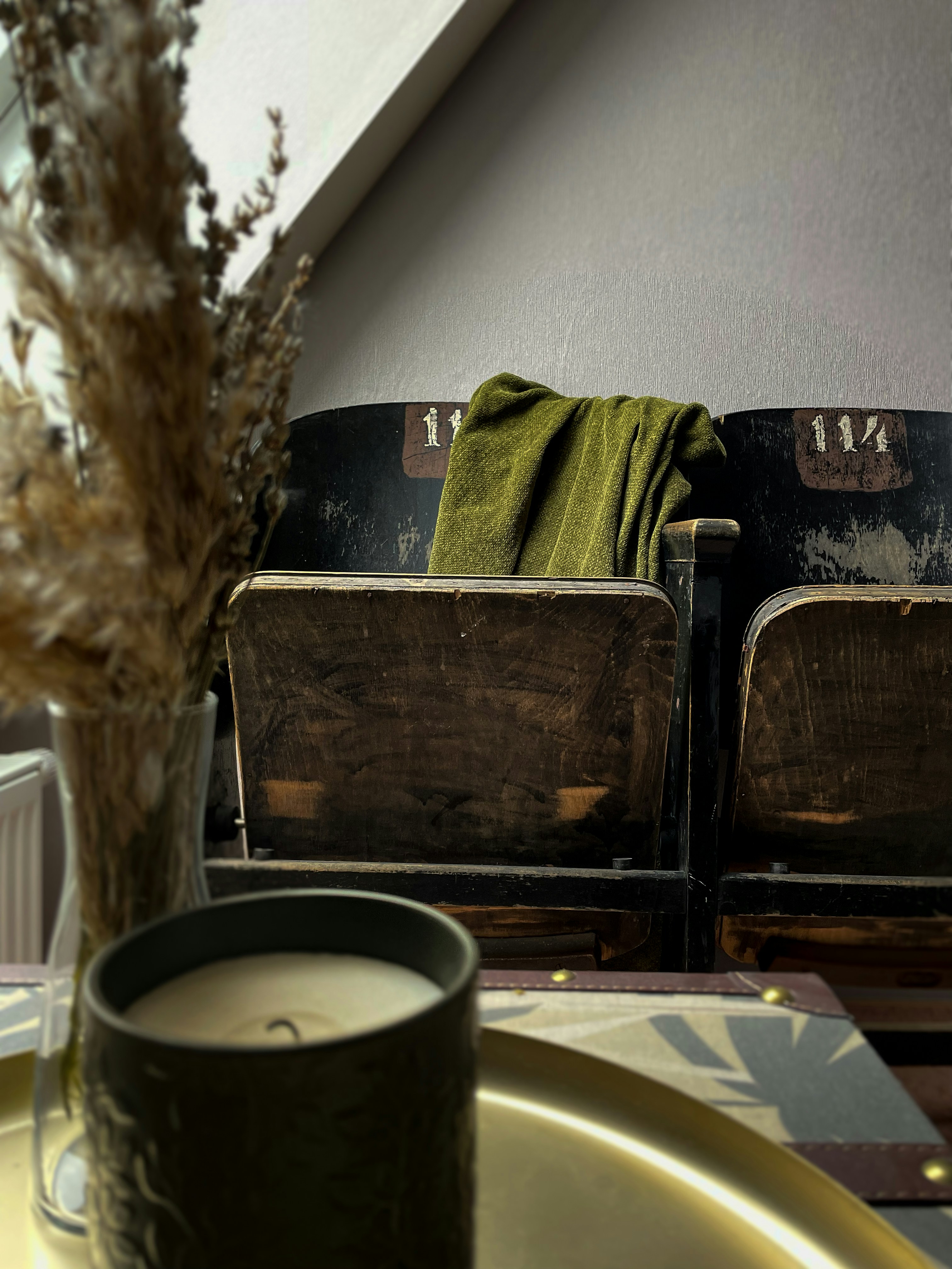 Moss-Green Drapery over Weathered Seats in a Quiet Dining Corner