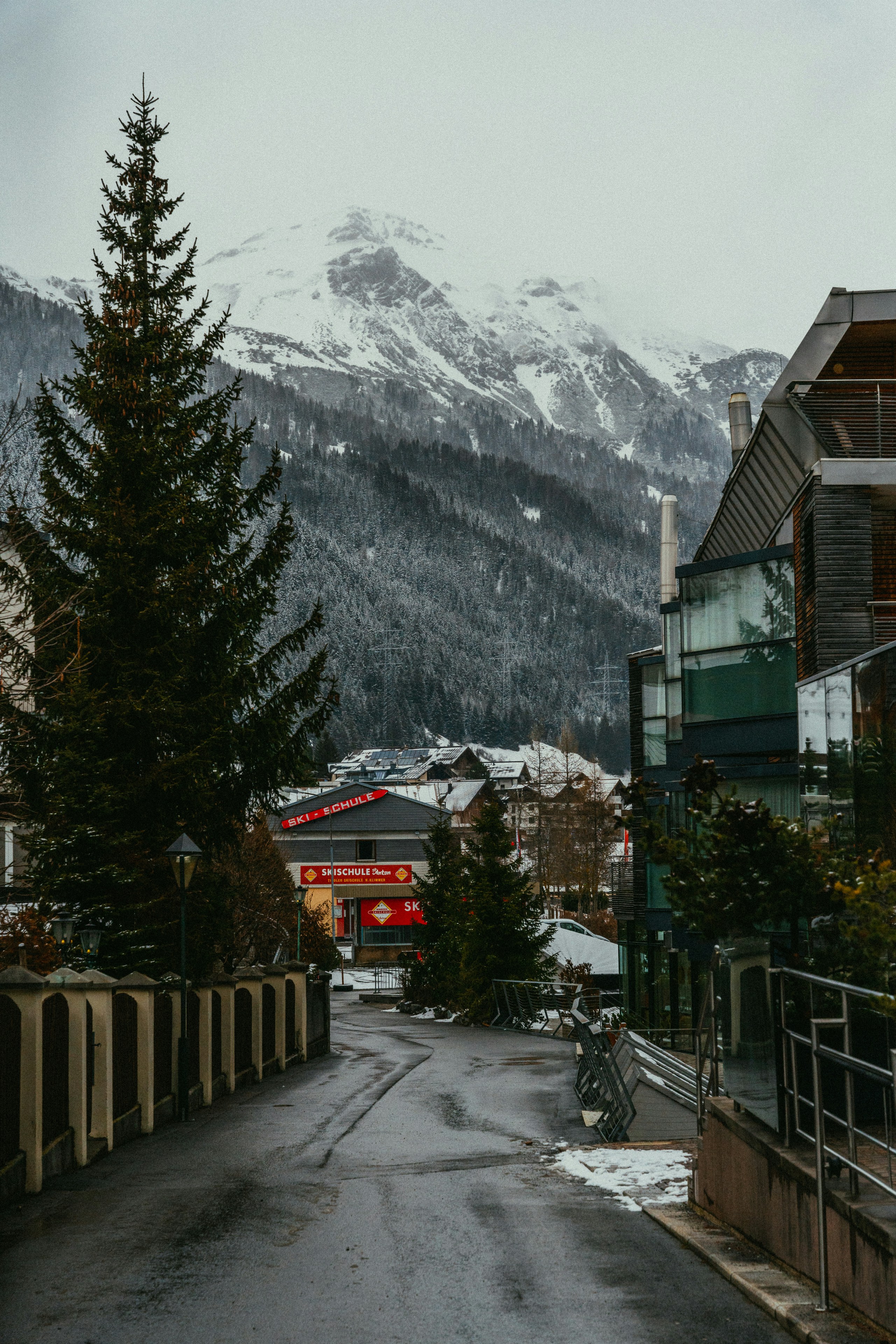  Alpine Street Veil: Snowy Peaks Over a Quiet Village