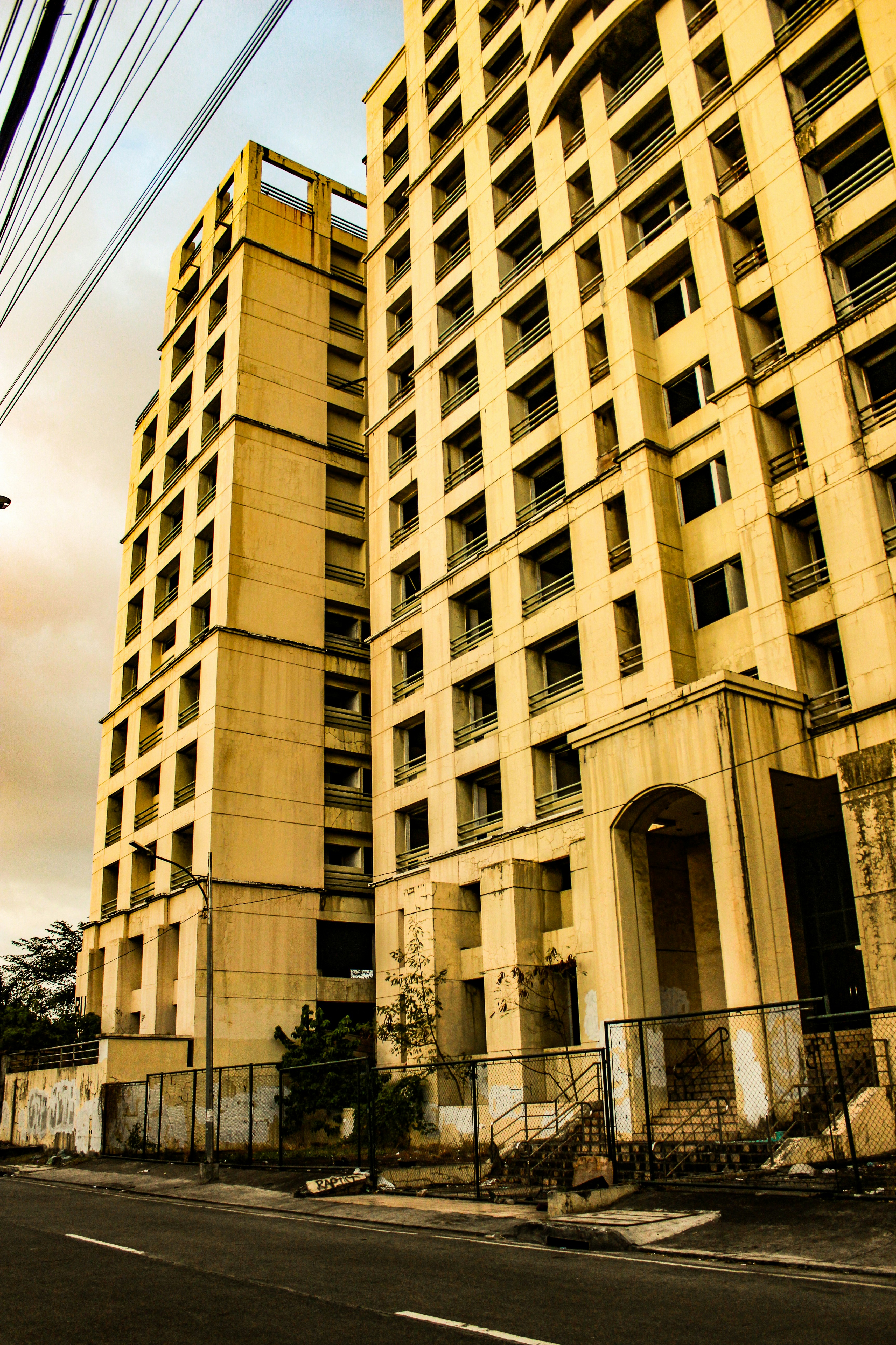 Golden Facade Monolith: An Abandoned High-Rise Drenched in Evening Light