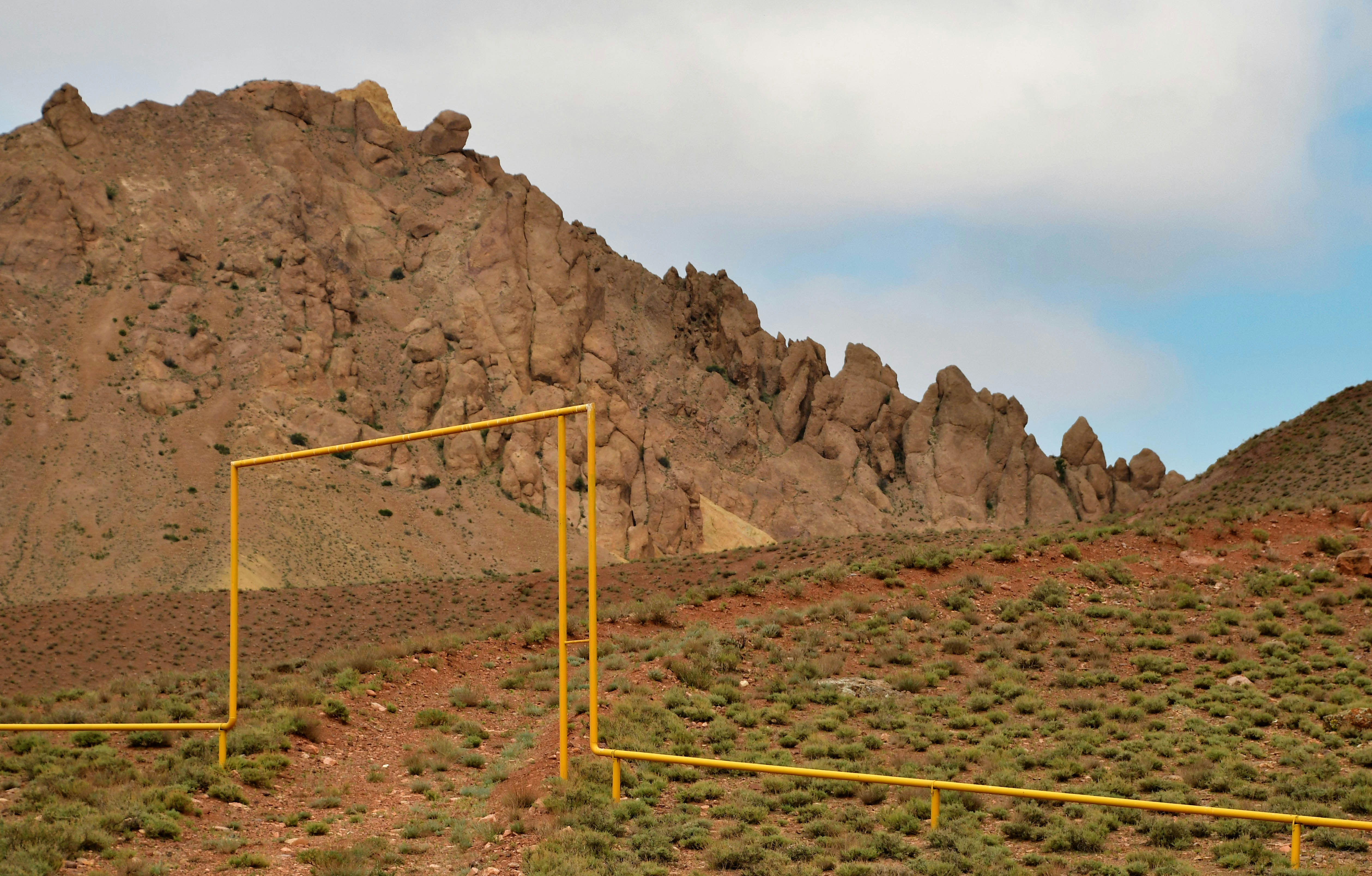 Desert Frame: A Yellow Gate Framing Red Hills