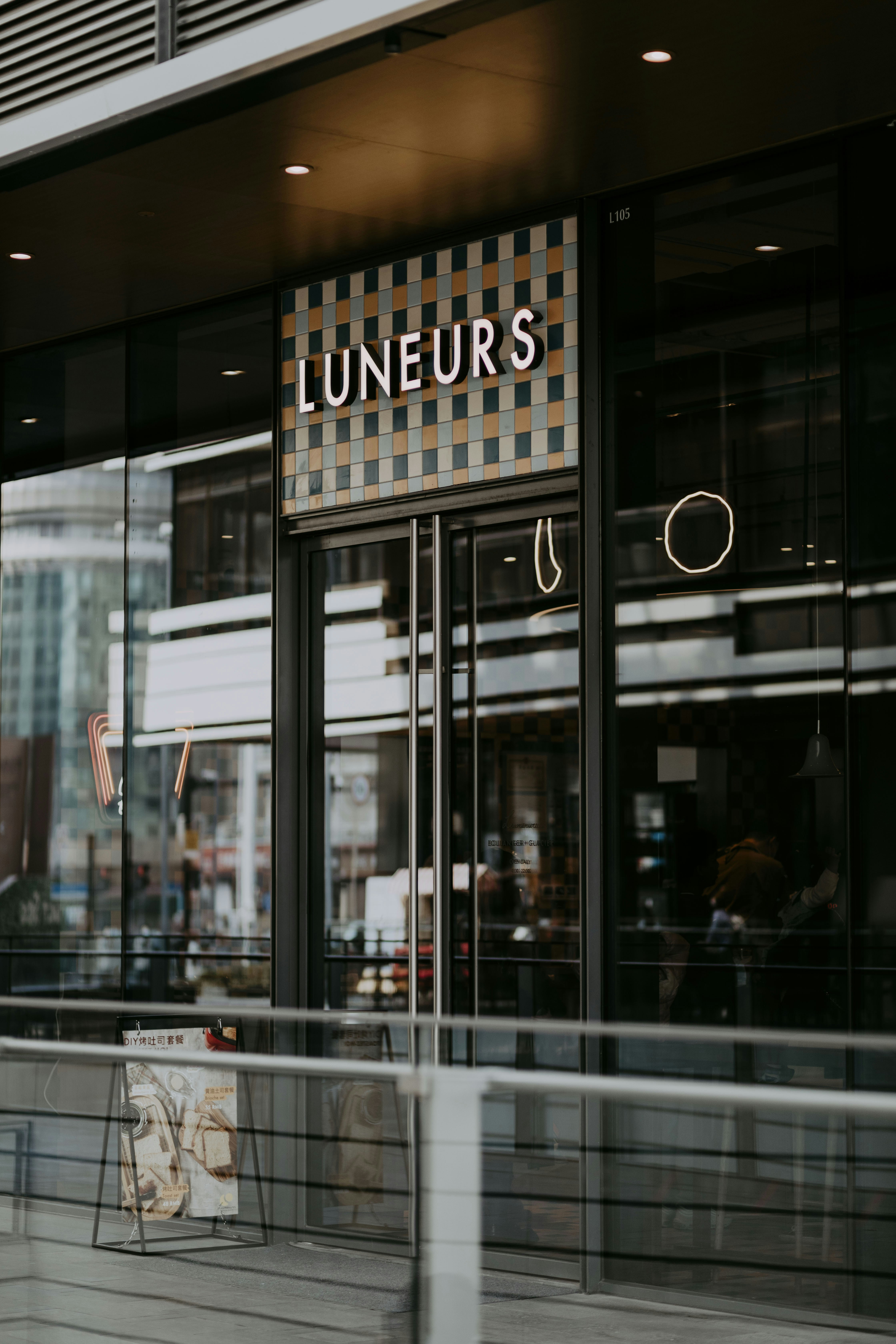 LUNEURS Through Glass: Reflections on a Checkerboard Facade