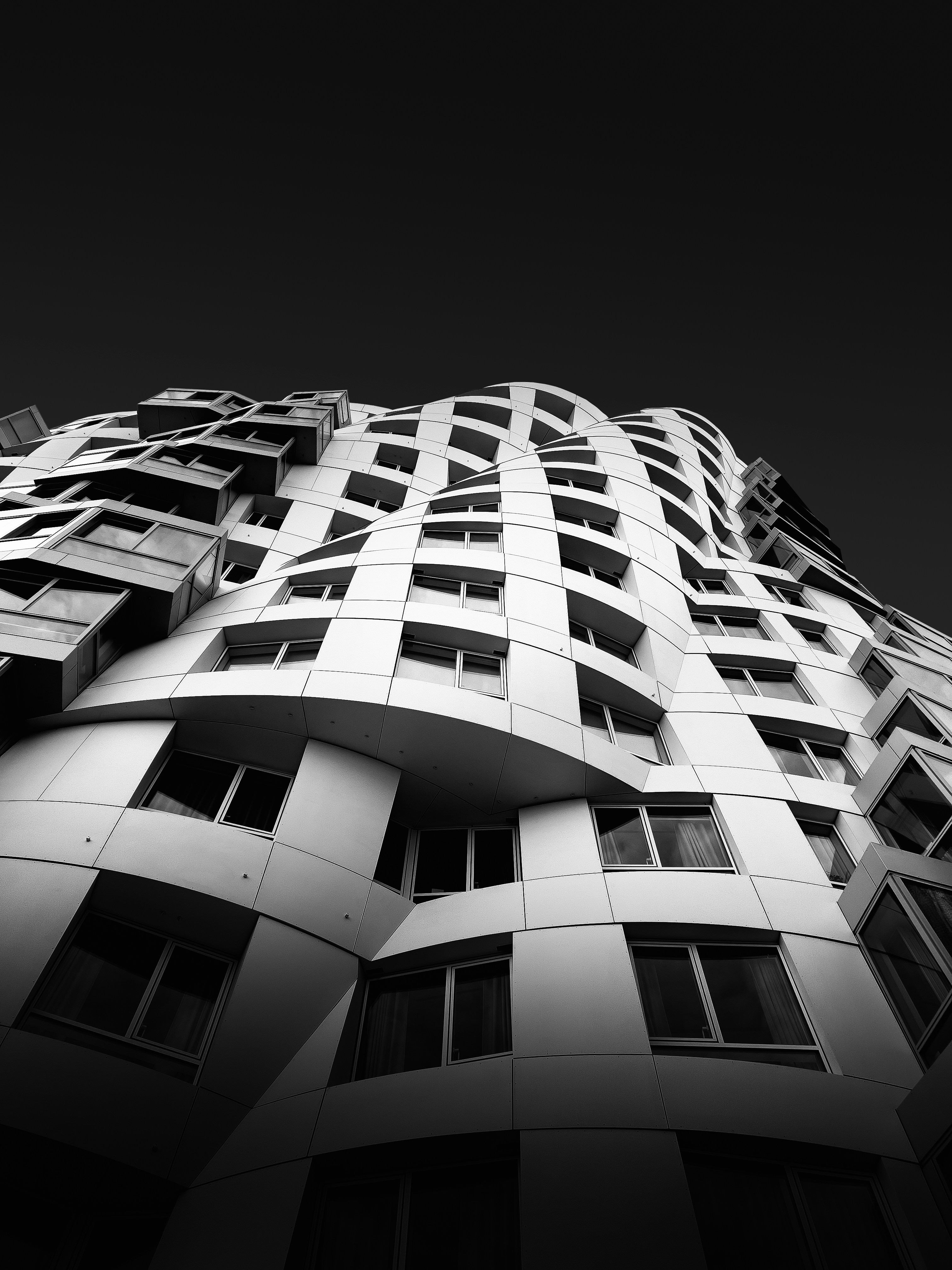 Curved Facade in Monochrome: A Tilted Portrait of Urban Architecture