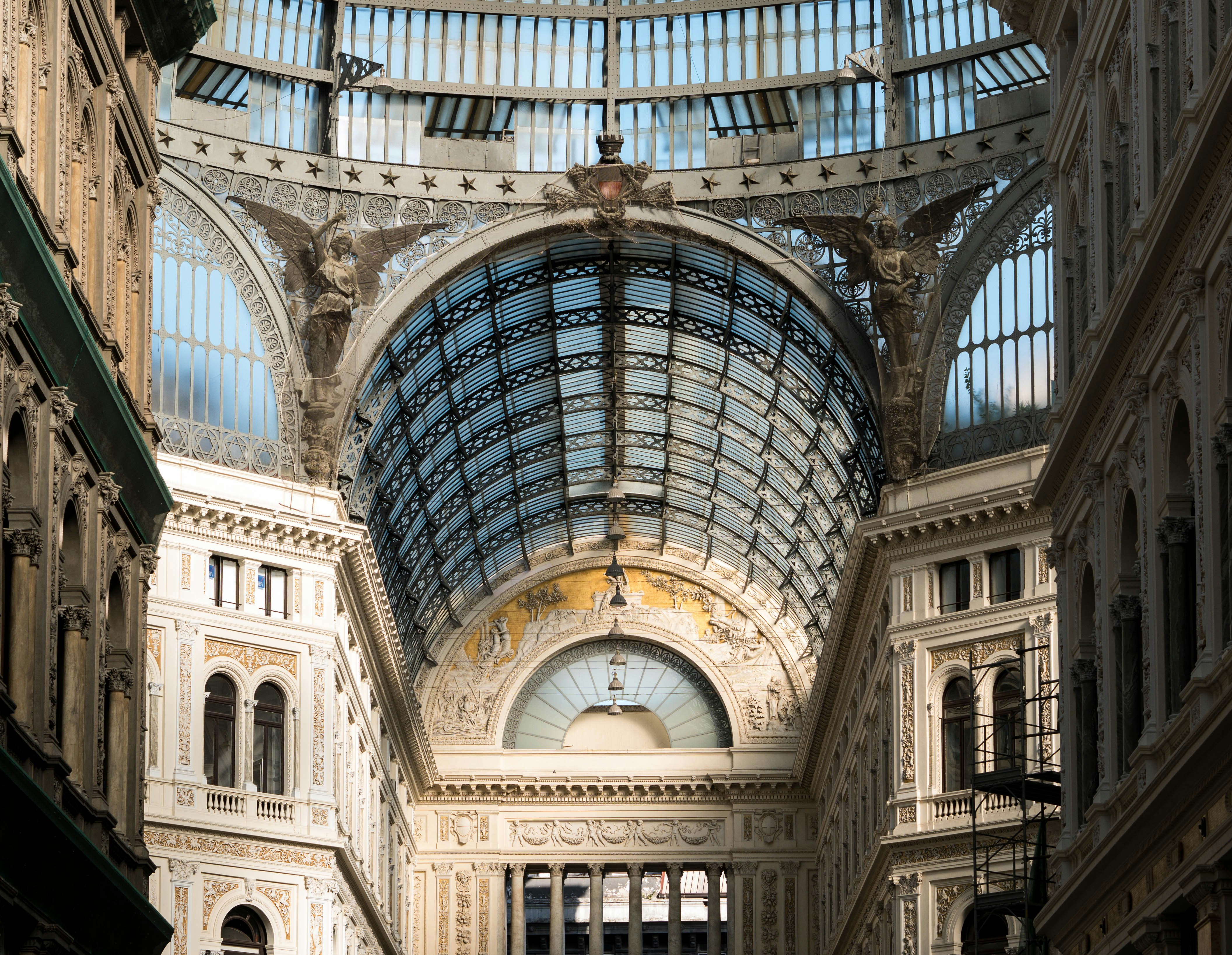 A large building with a clock on the ceiling photo – Free Building ...