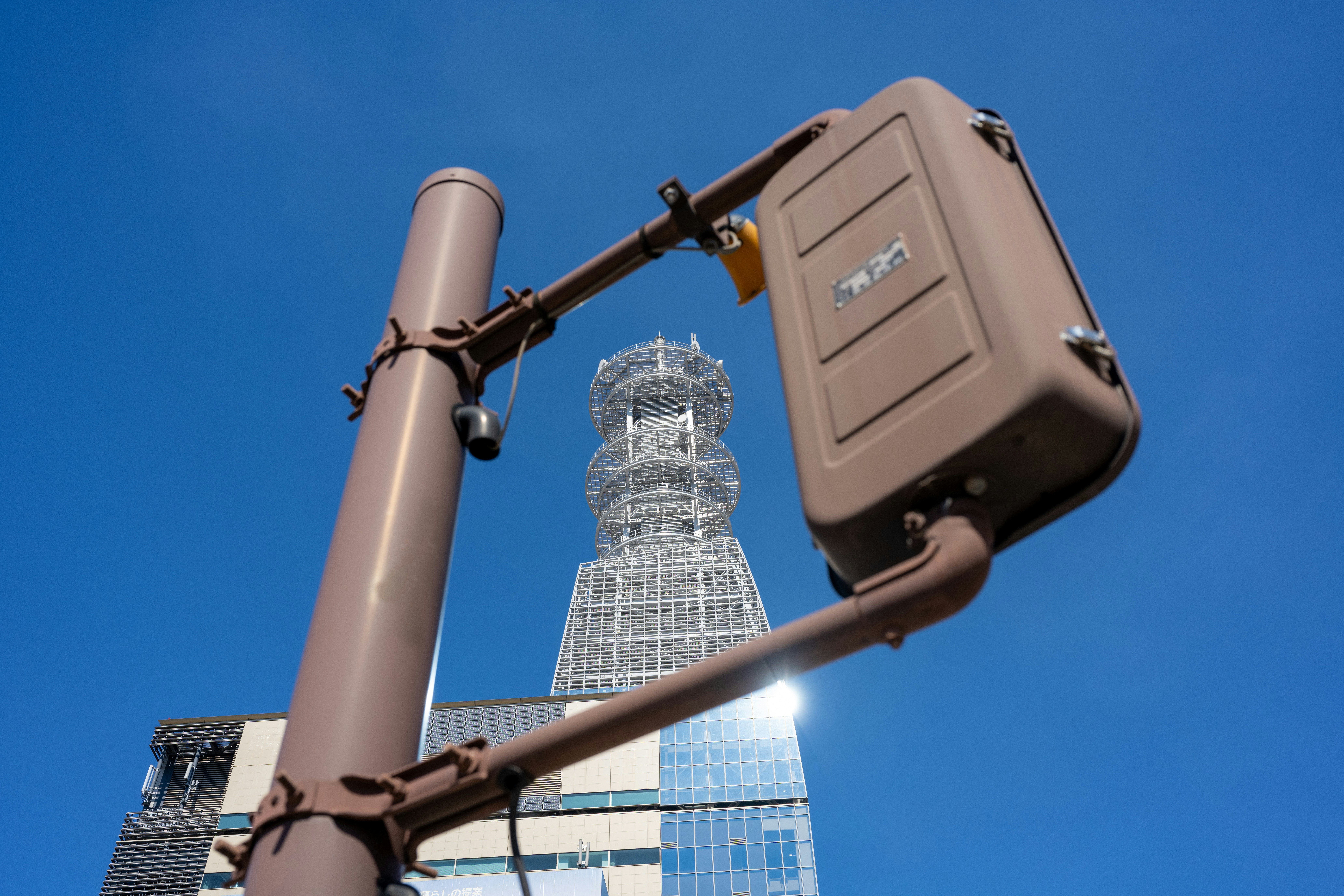 a street light with a building in the background