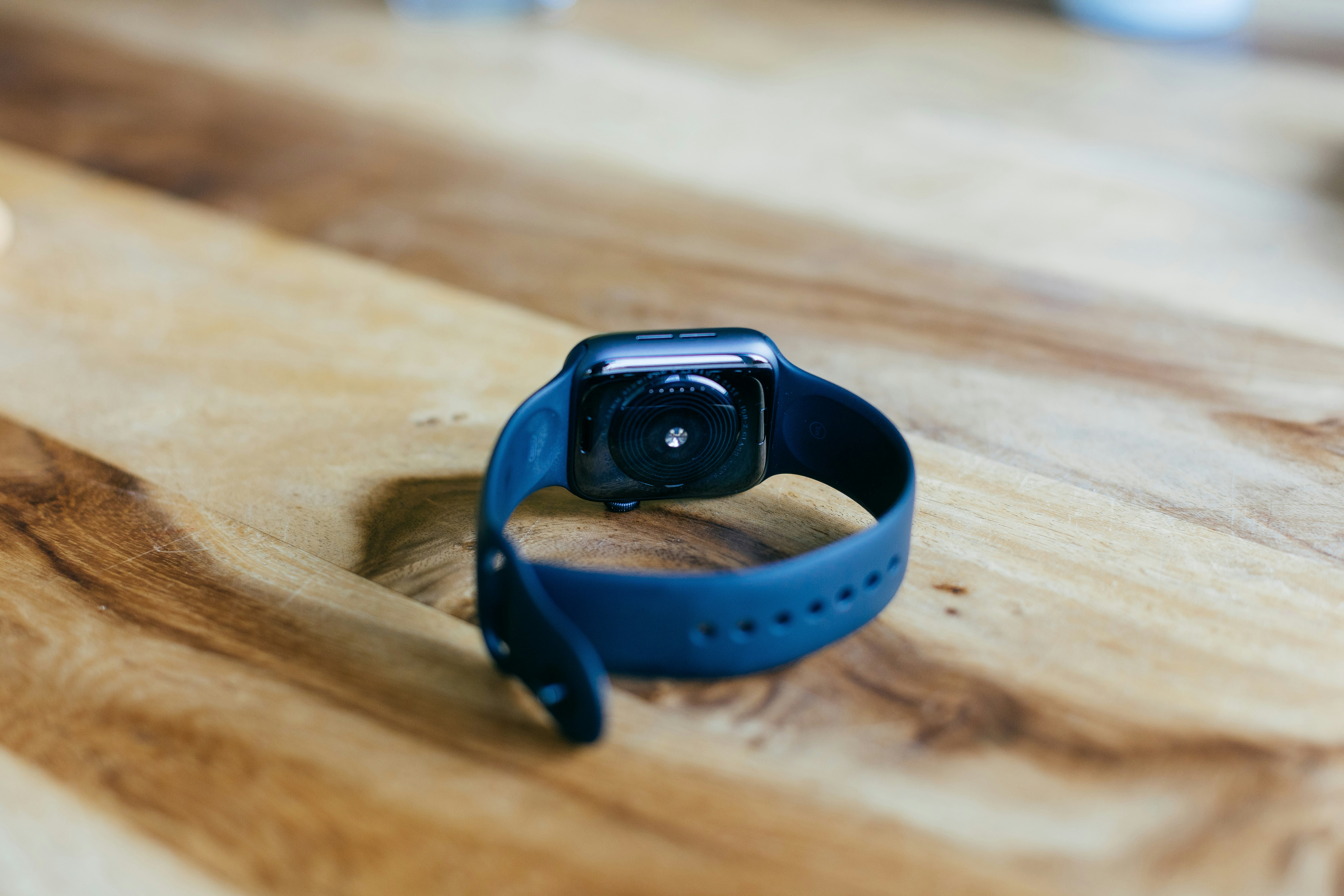 A smart watch sitting on top of a wooden table photo – Free Apple watch ...