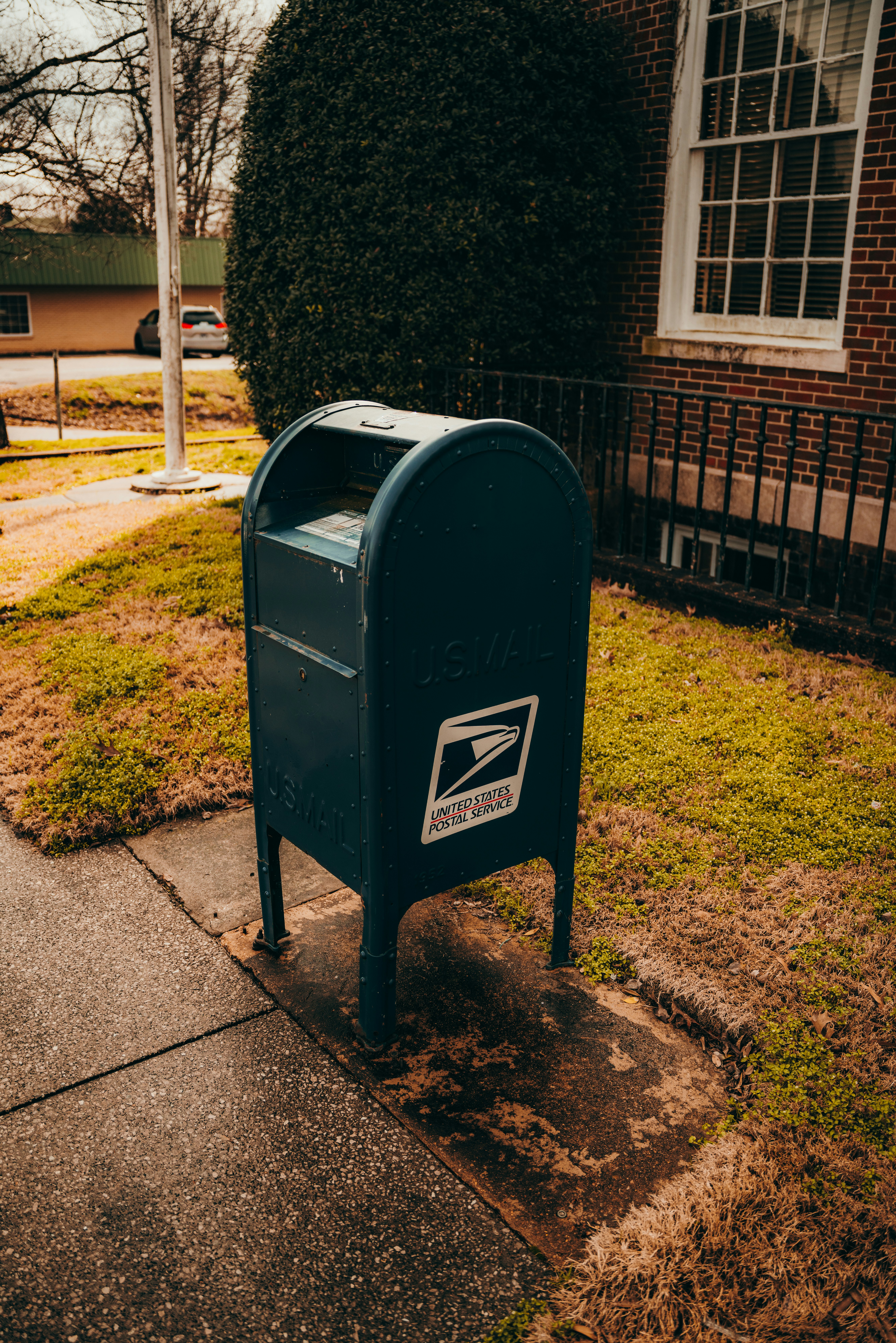 A mailbox on a sidewalk in front of a house photo – Free Mailbox Image ...