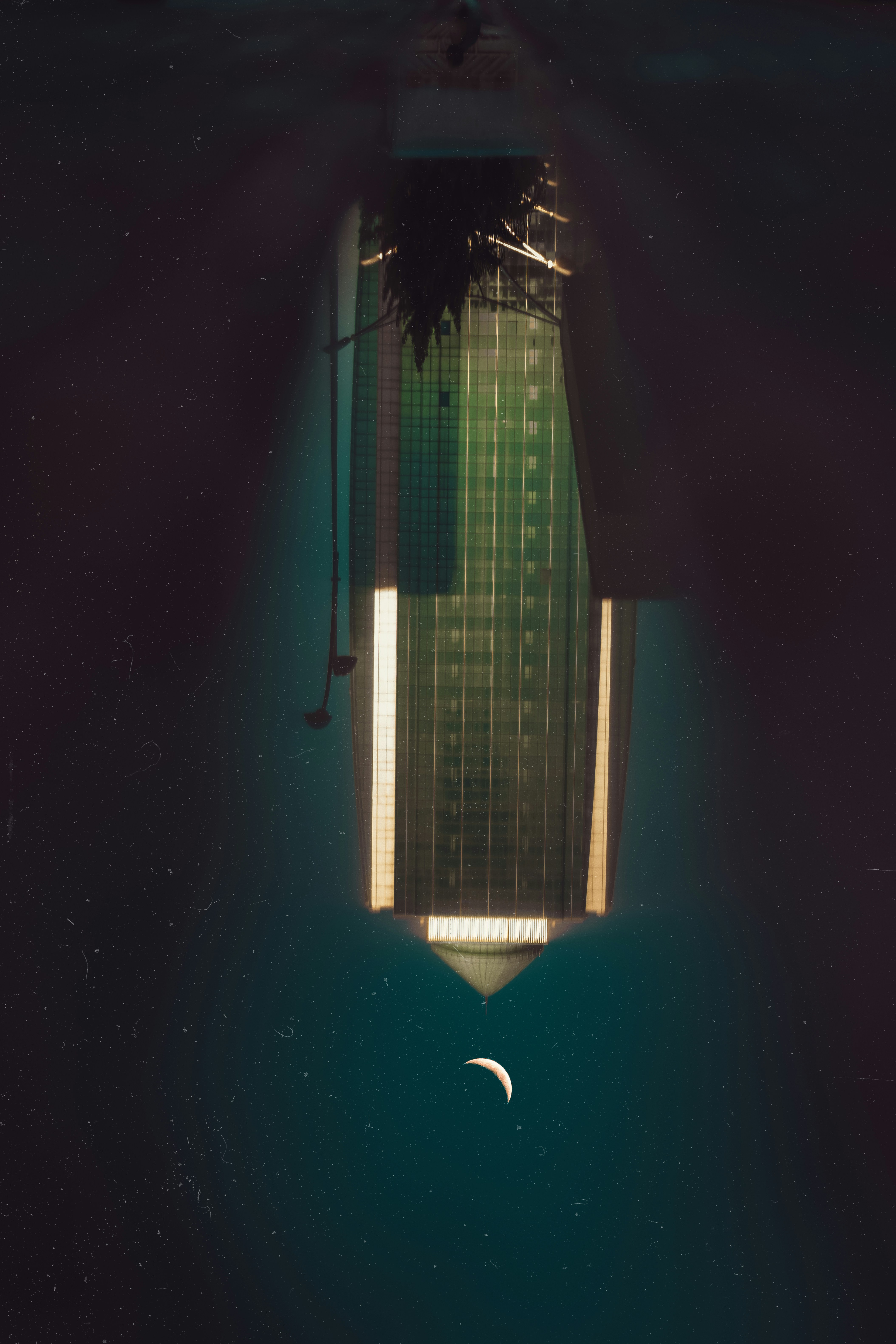 A modern skyscraper reflecting a crescent moon, creating a surreal interplay between architecture and nature.