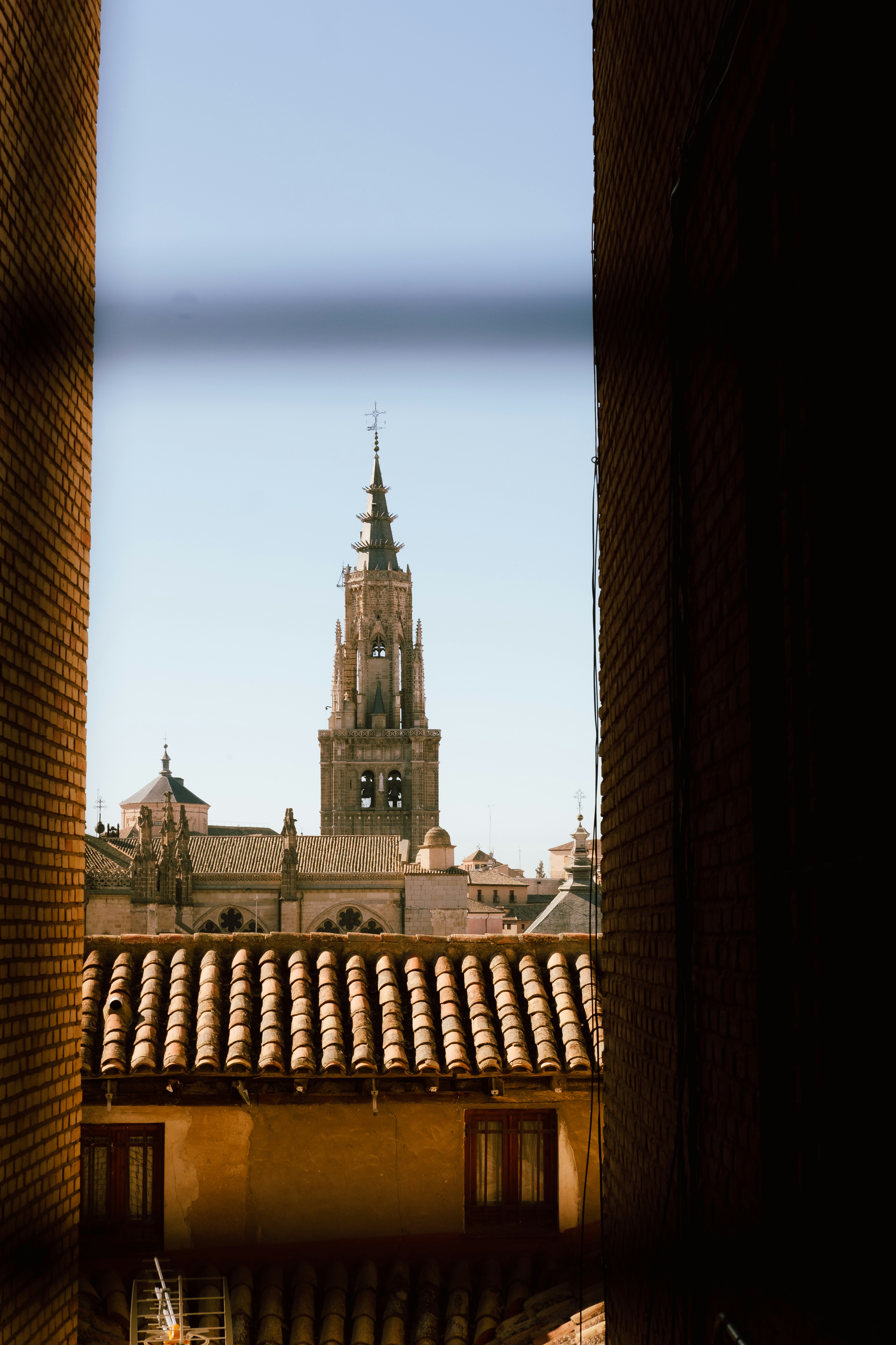 Cathedral Spire Through the Cloister: A Narrow View to the City