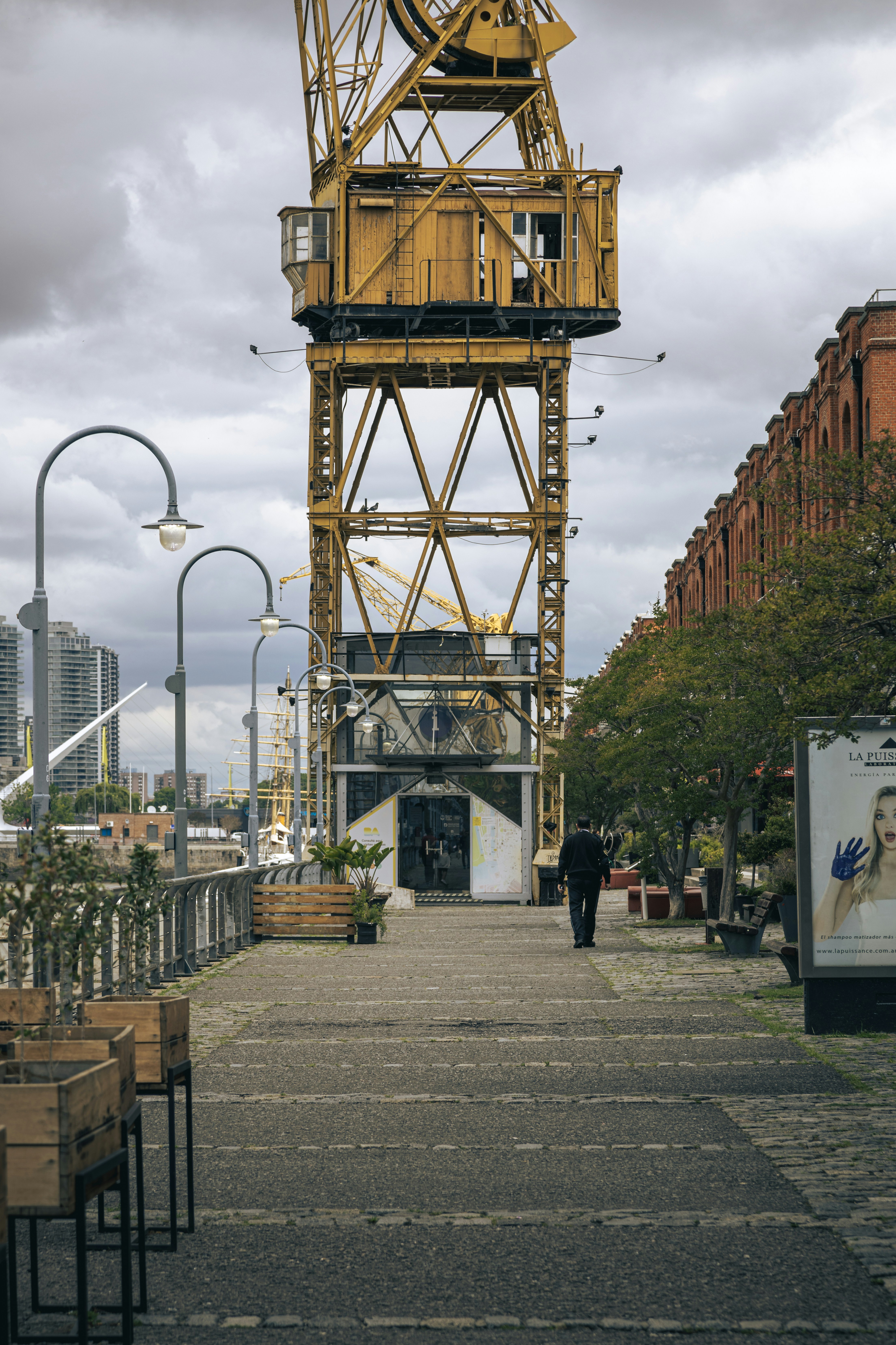 Industrial Sentinel: A Pierside Crane Looms Over a Quiet Promenade