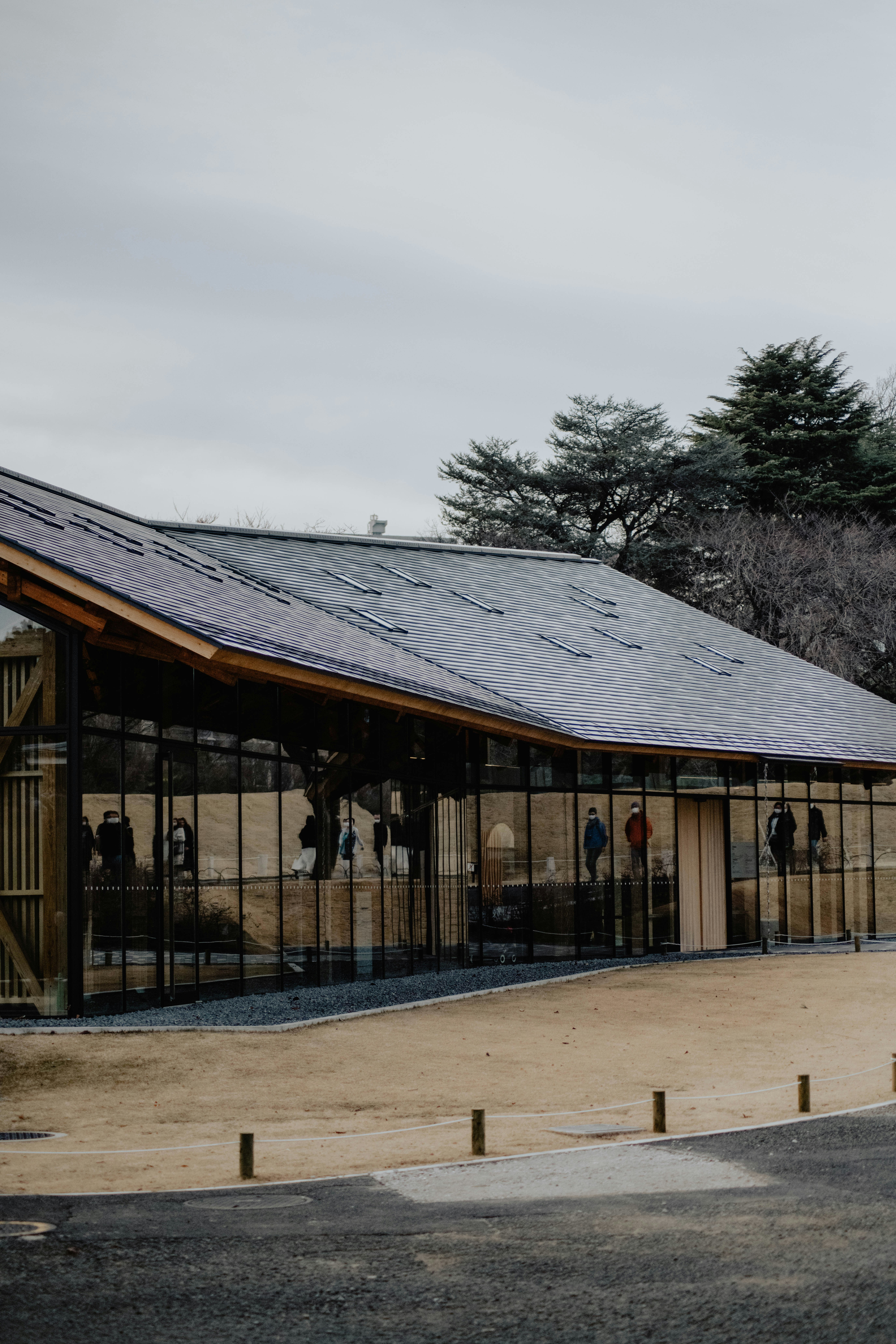 Glass-walled Pavilion Quietly Framed by a Slate Roof