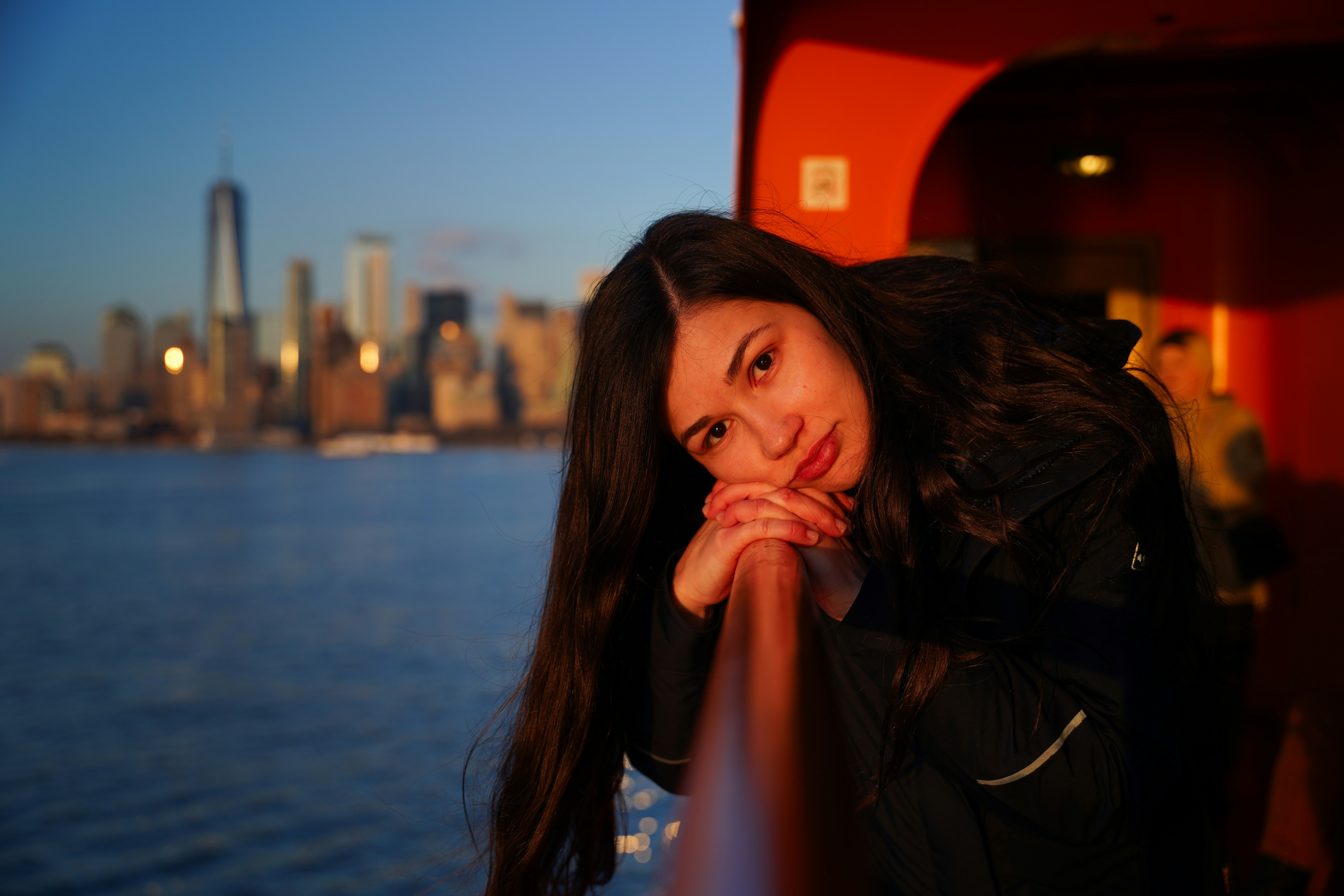 a woman leaning on a railing looking at the camera