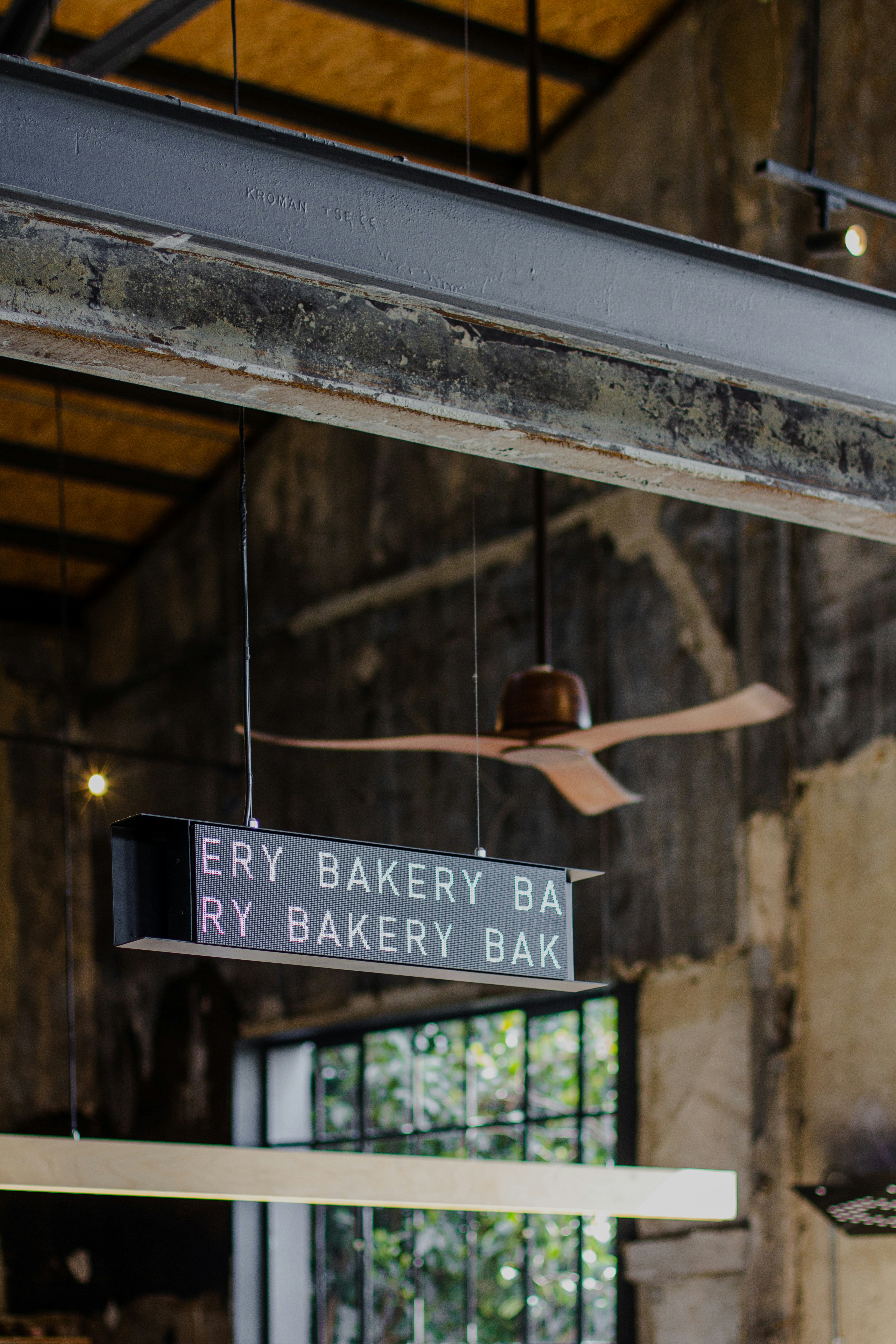 A sign hanging from the ceiling of a bakery photo – Free Interior Image ...