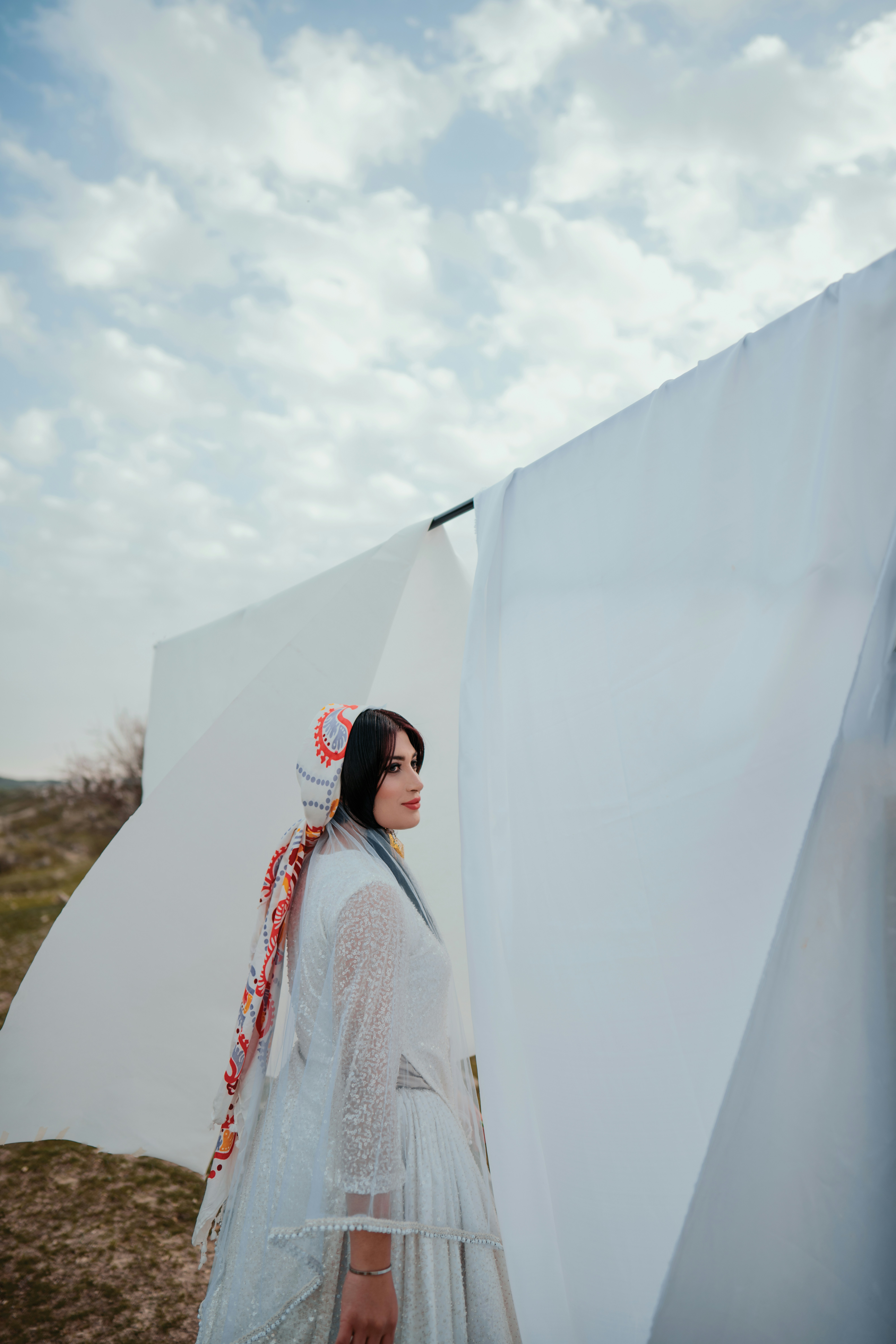 Portrait in White: A Quiet Gaze Between Draped Panels