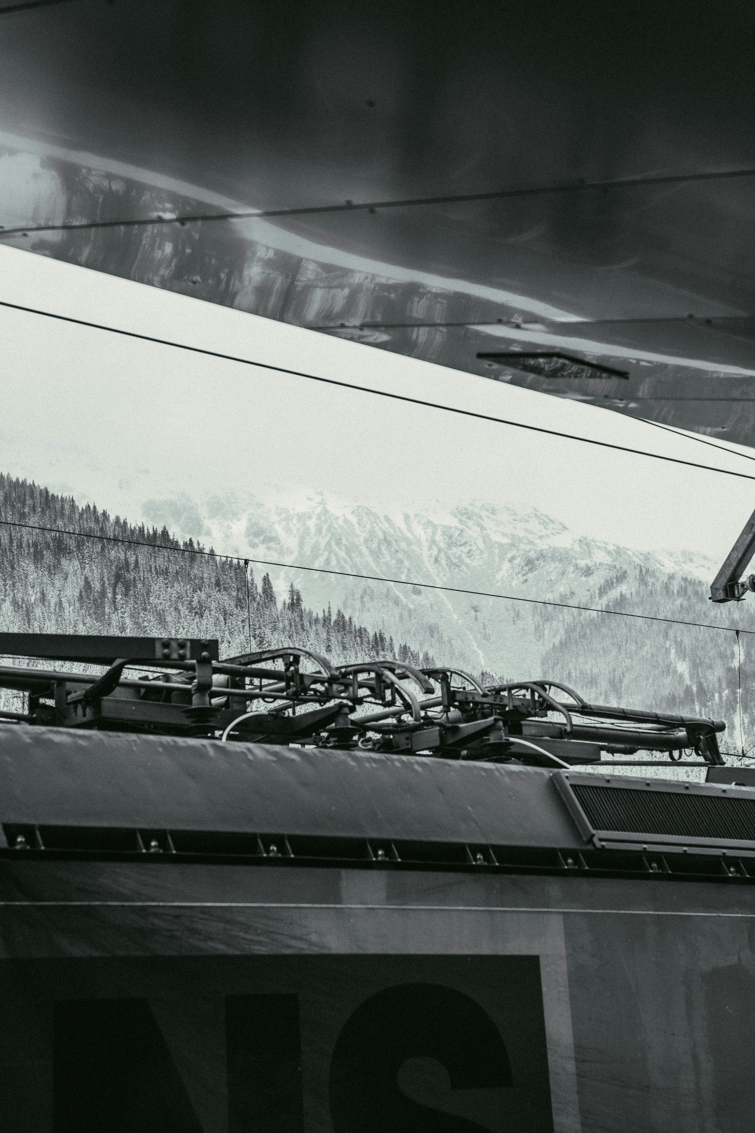 a black and white photo of a ski lift