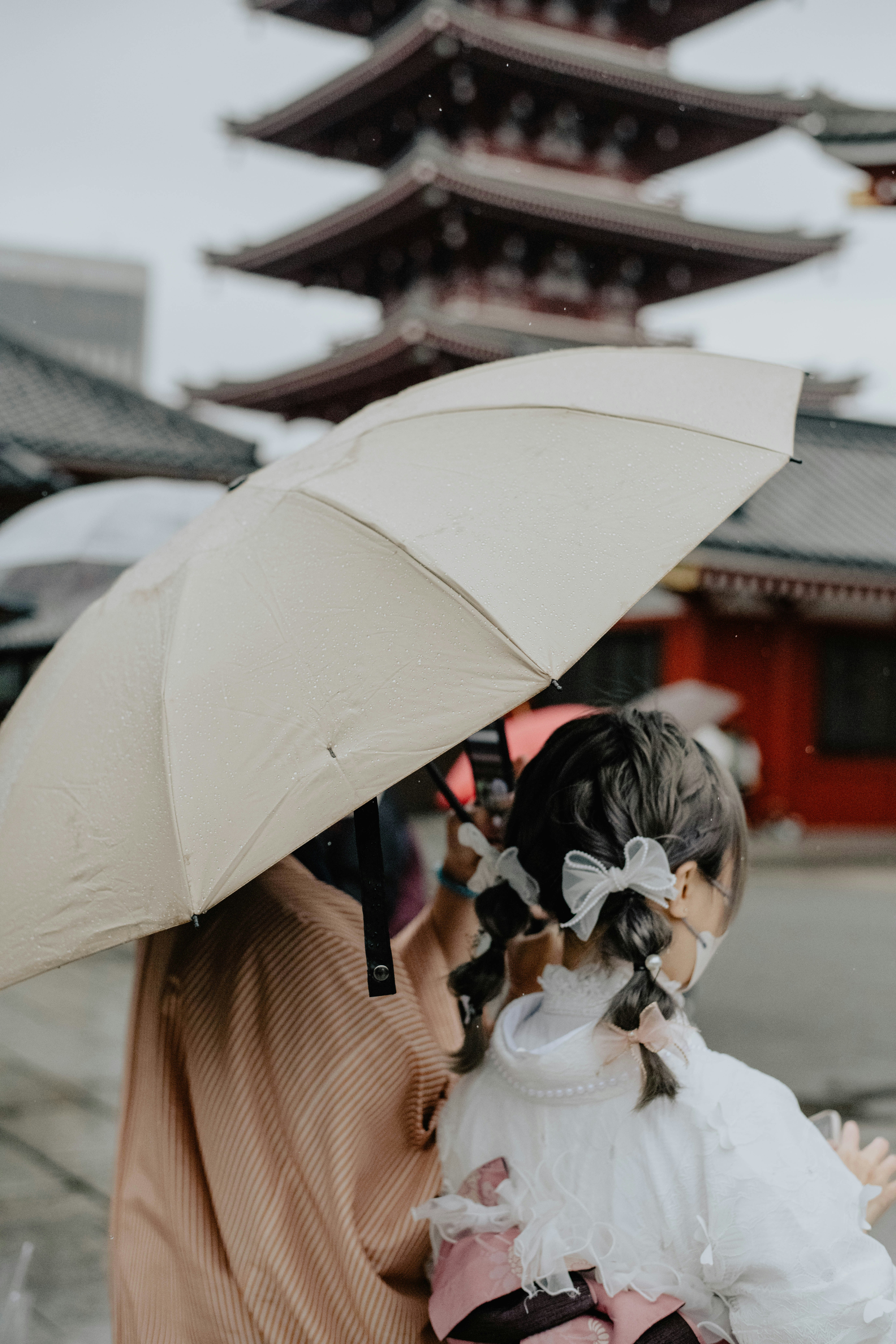 a woman holding a child under an umbrella