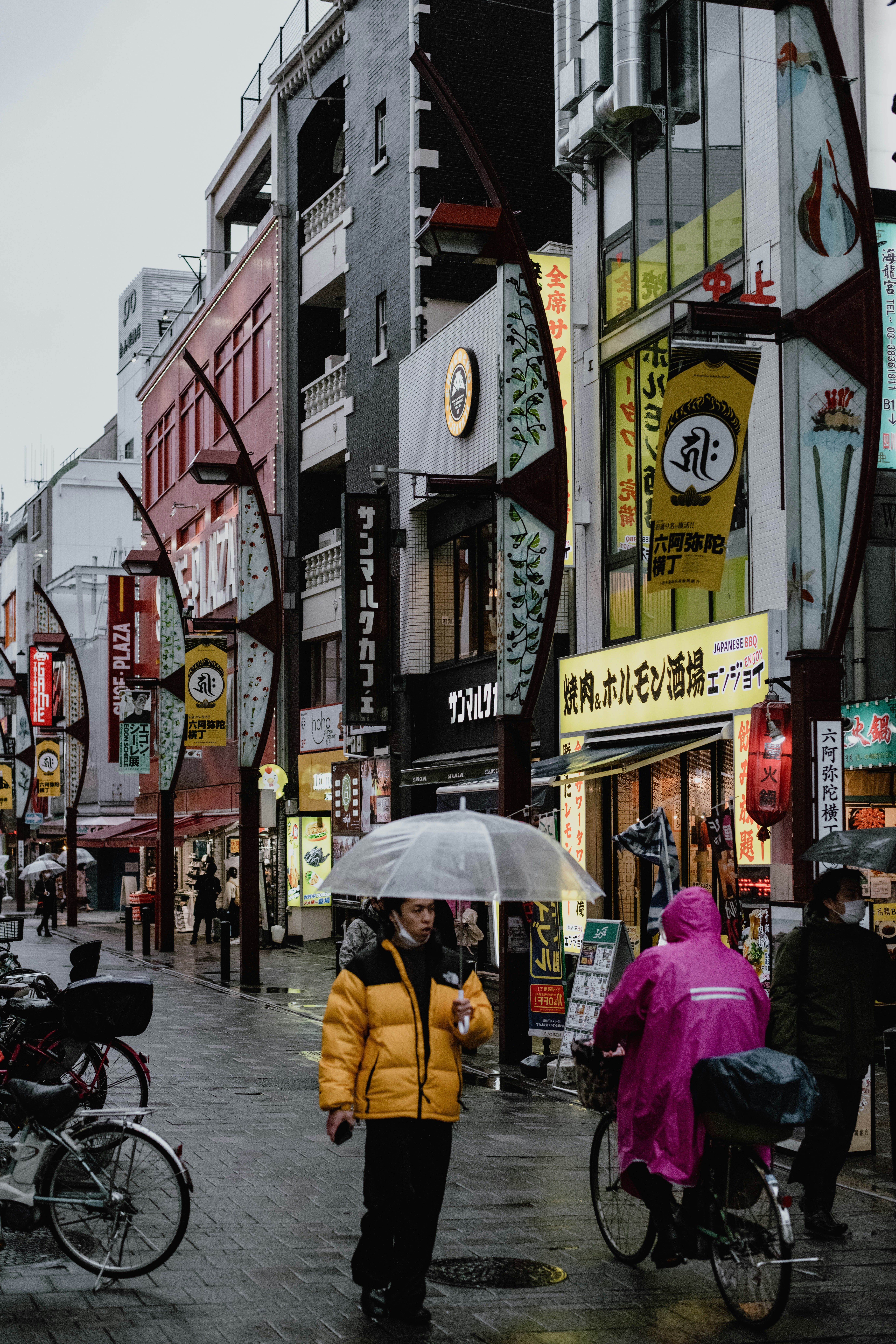 Street Rain, Yellow Parka, and Neon Signs: Tokyo Thoroughfare in the Rain