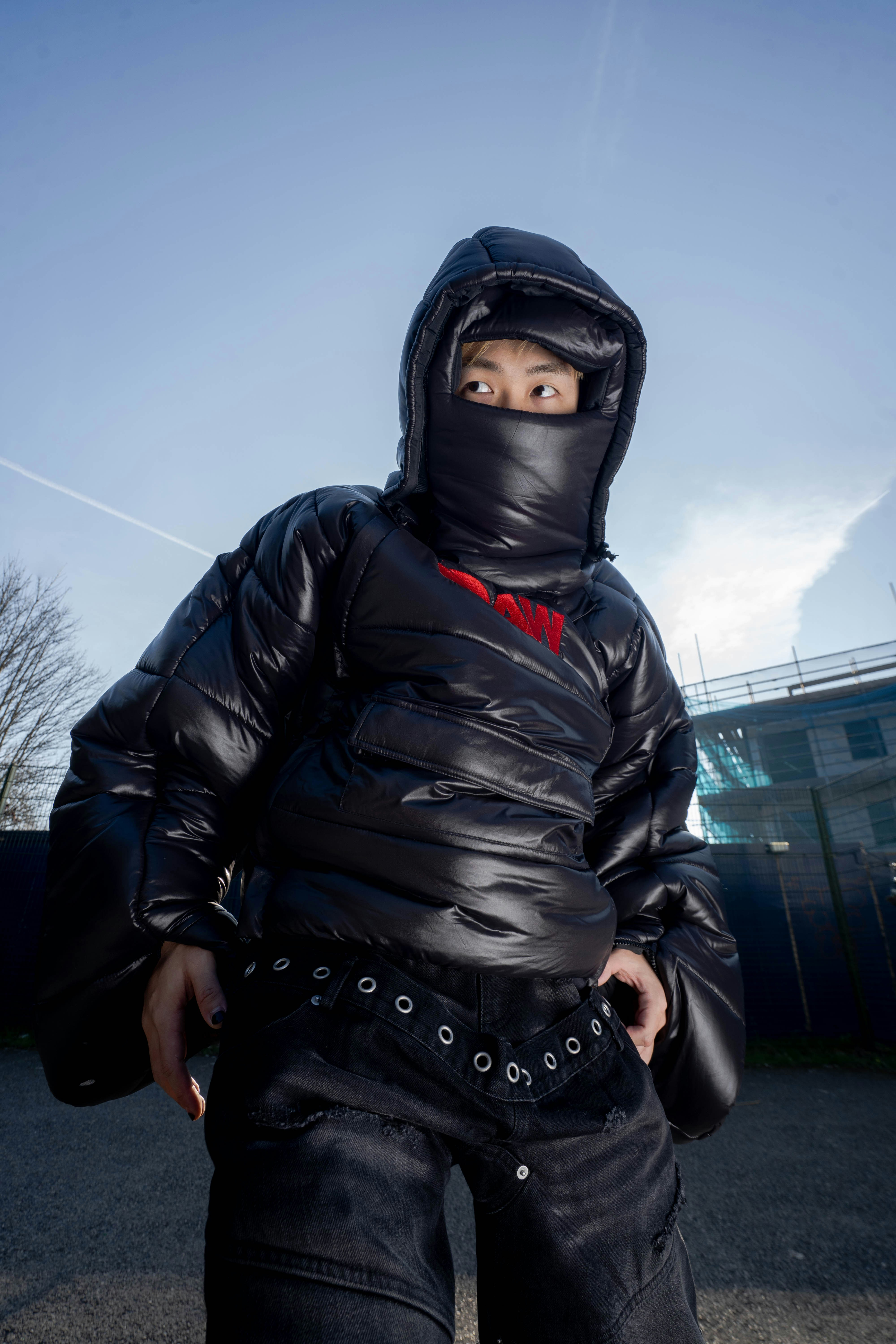 Eyes in the Hood: A Winter Portrait in Glossy Black