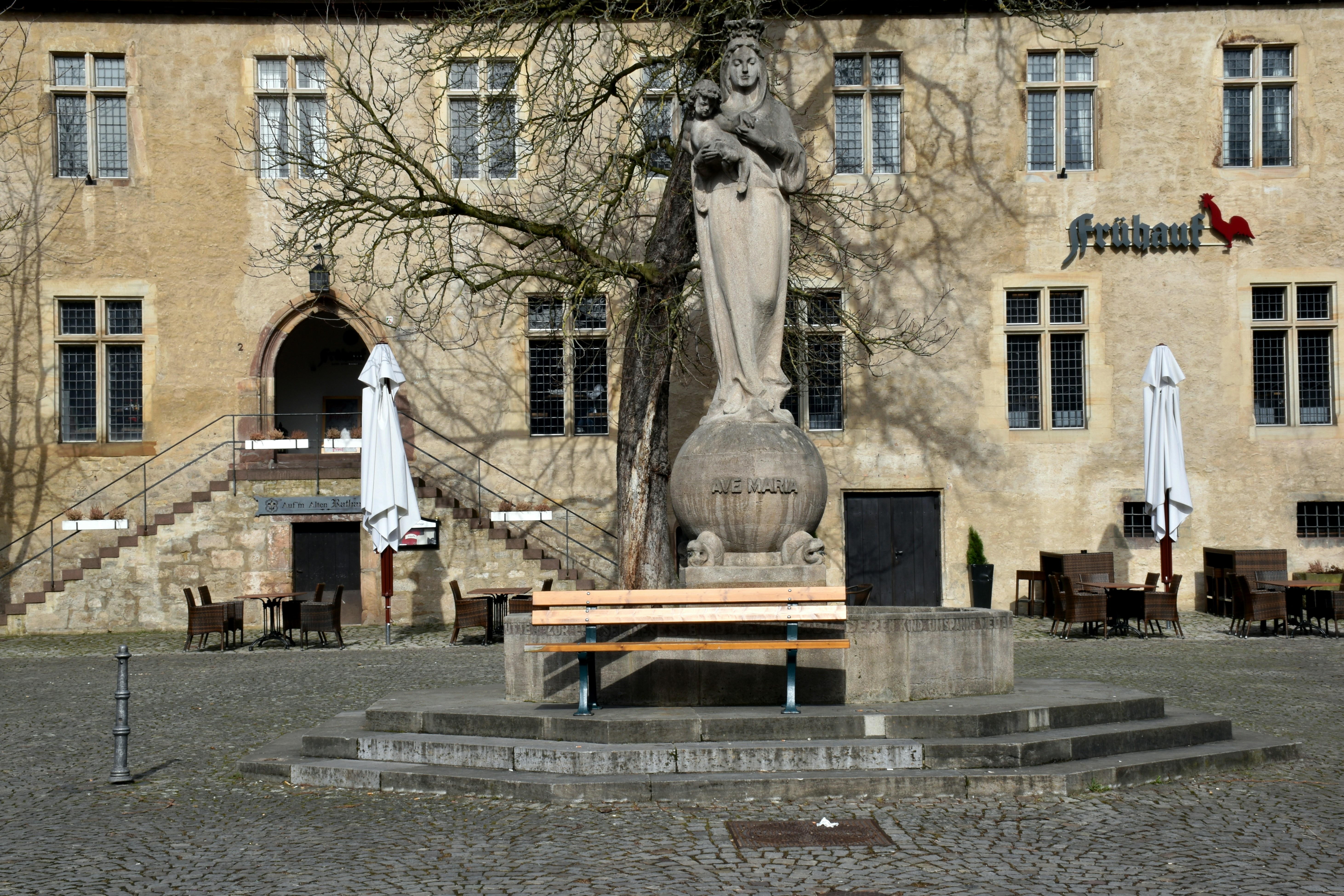 Centerpiece Statue Fountain Framed by Cobblestones in a Quiet Town Square