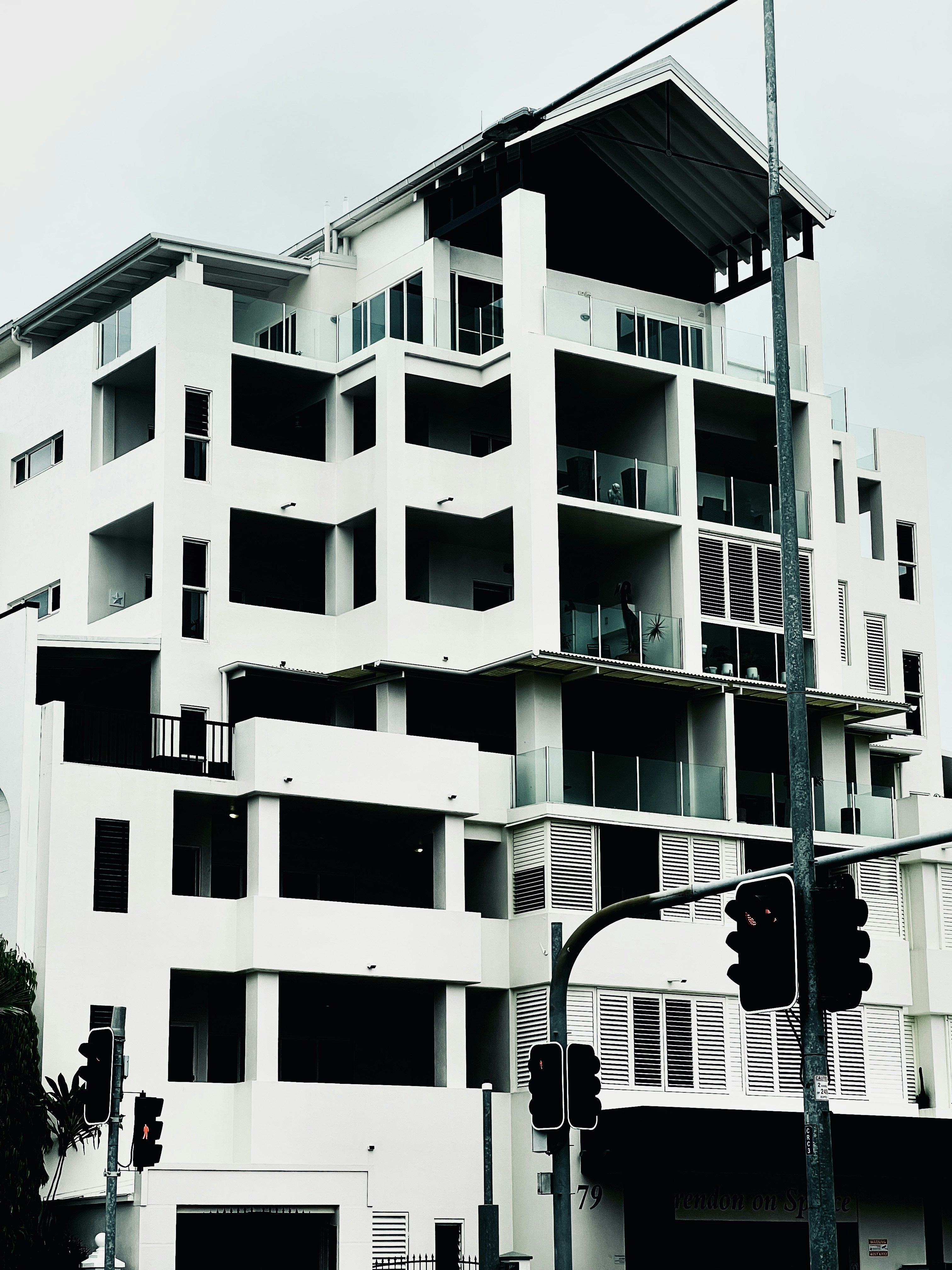 Contemporary apartment building showcasing a minimalist aesthetic with expansive balconies and geometric lines.