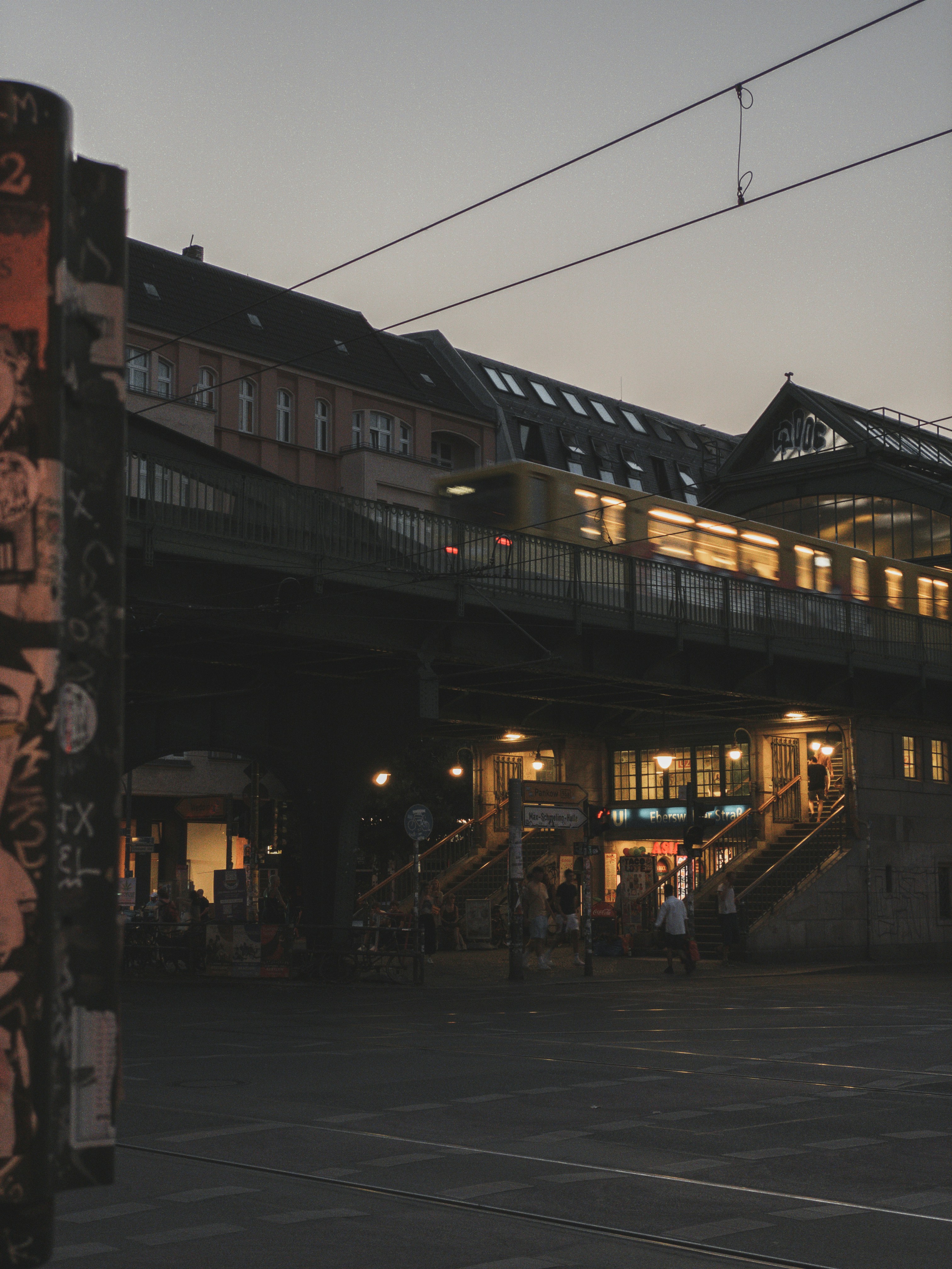 Evening Platform: Trains, Windows, and Neon Amid a Quiet Station