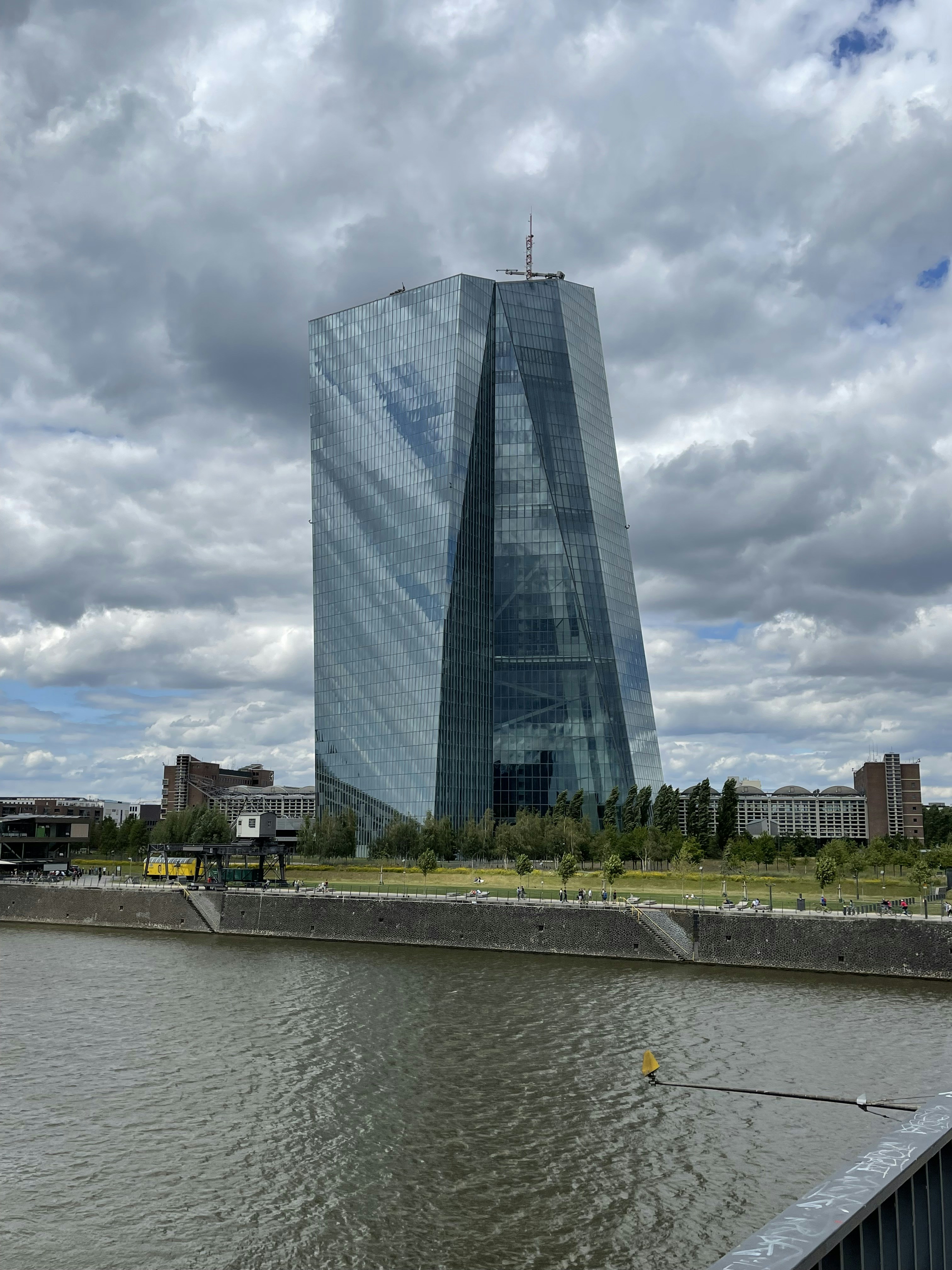 Prism Tower by the River: Glass Facade Catching the Cloudy Light