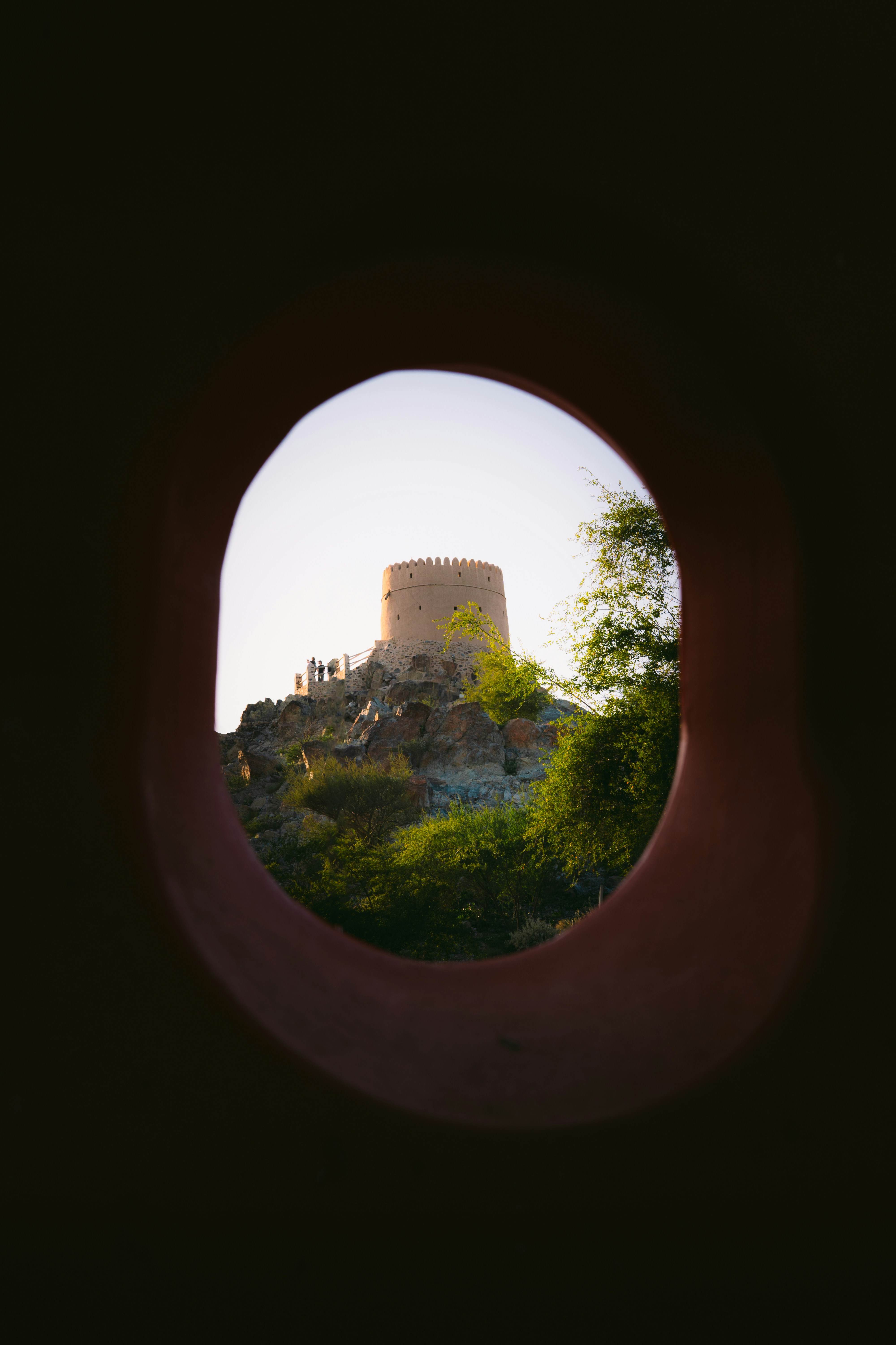 A view of a castle through a hole in a wall photo – Free Hatta - dubai ...