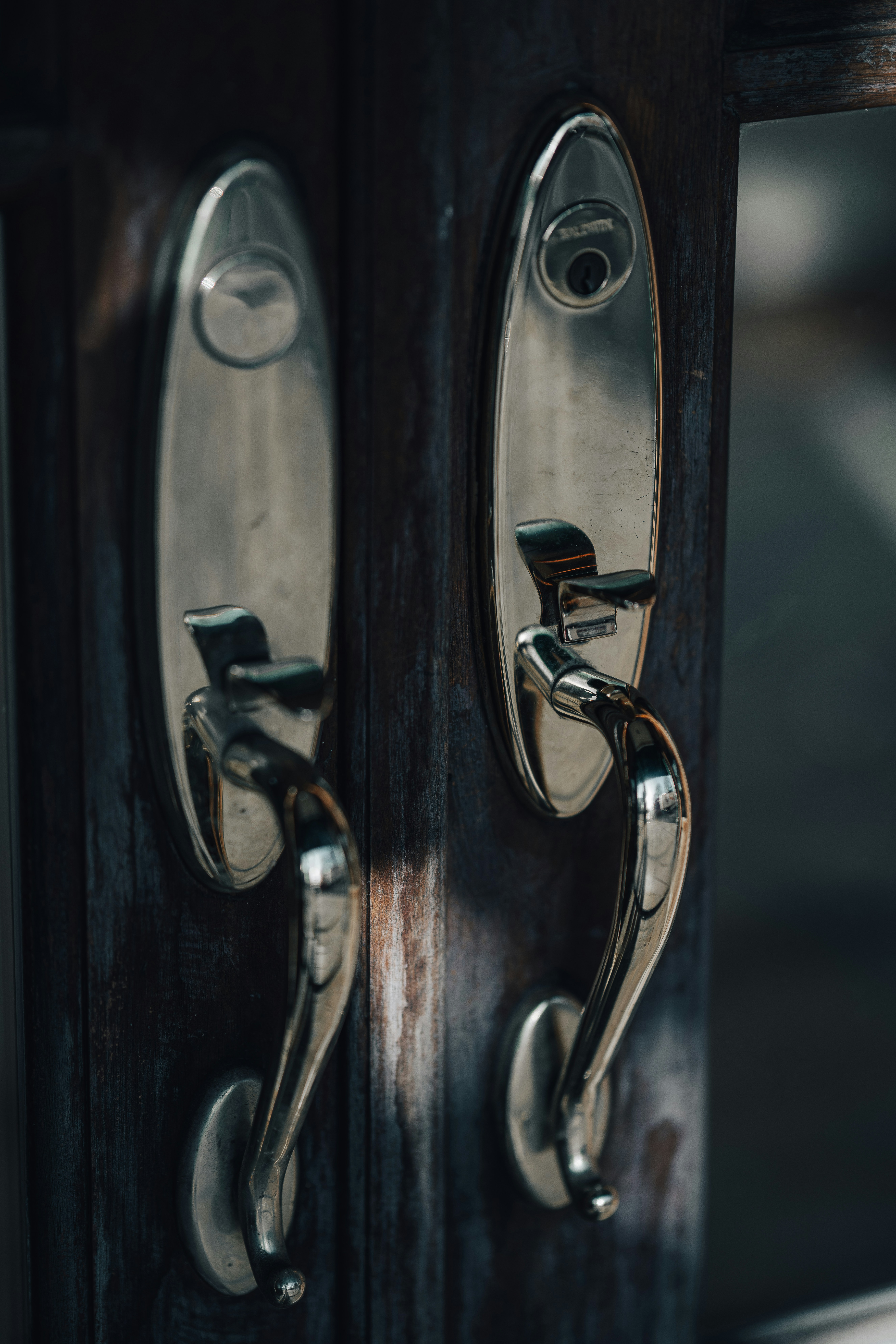 A close up of a door handle on a wooden door photo – Free Gun Image on ...