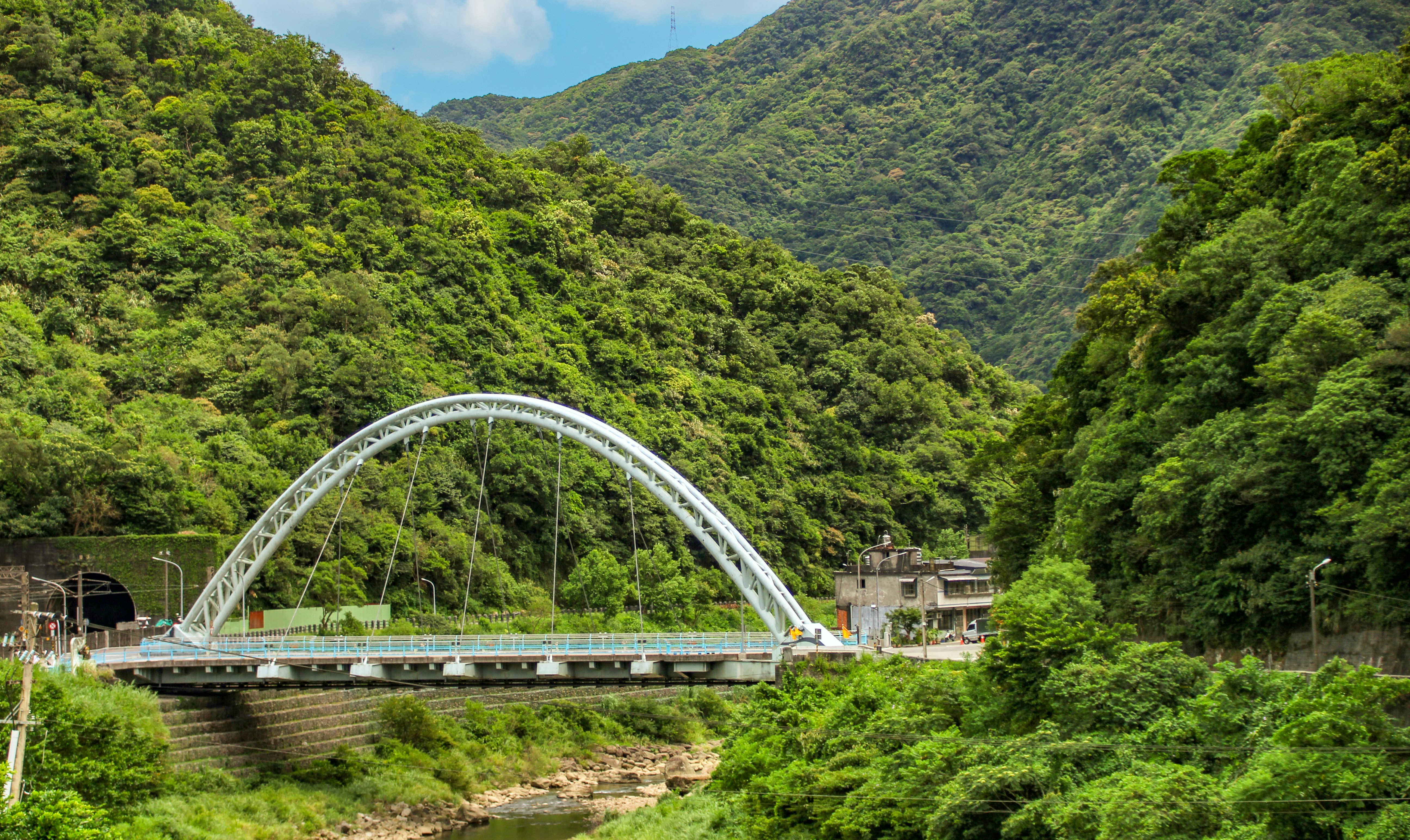 White Arch Bridge Framing a Verdant Gorge