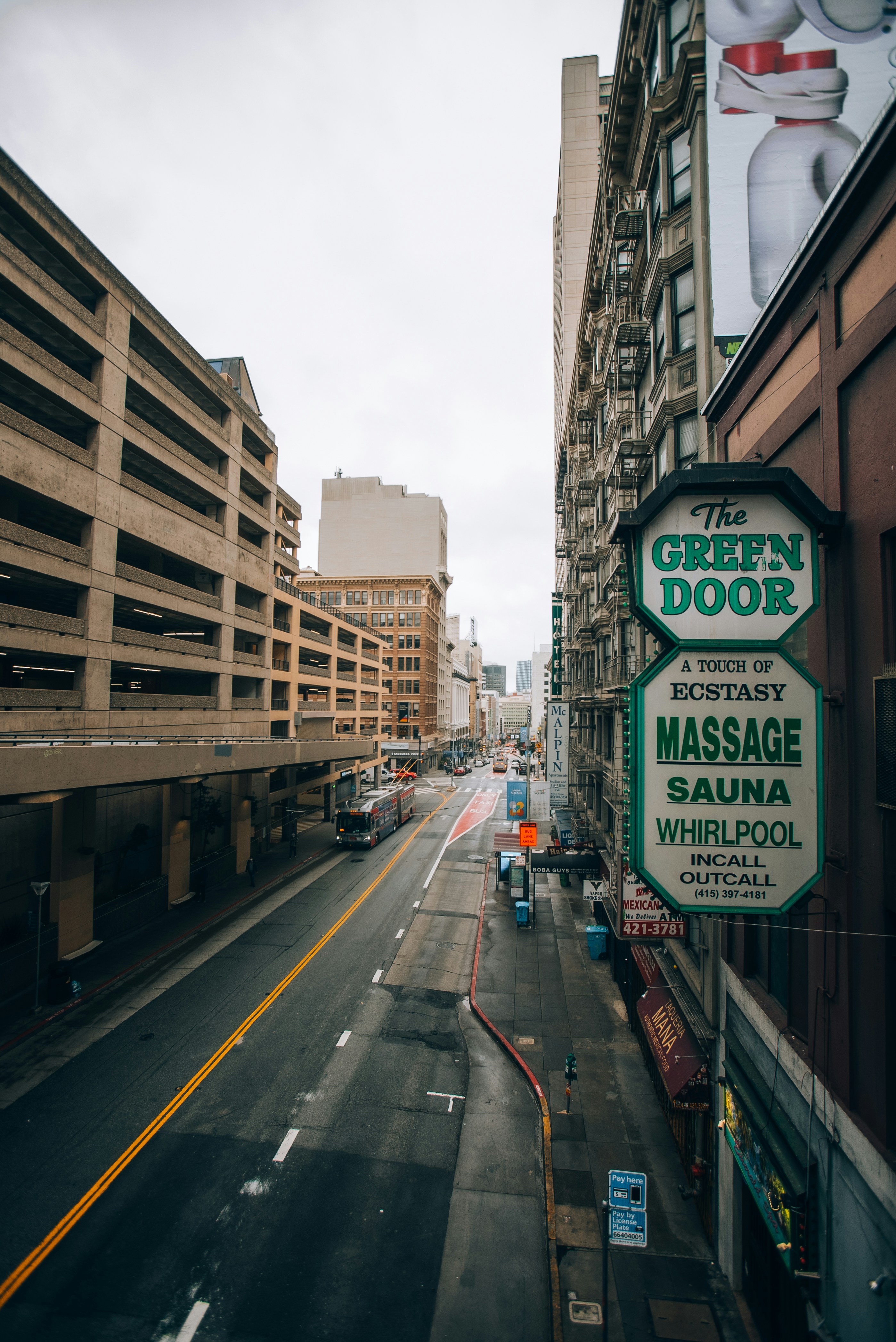 A street with a green door sign on the side of it photo – Free San ...